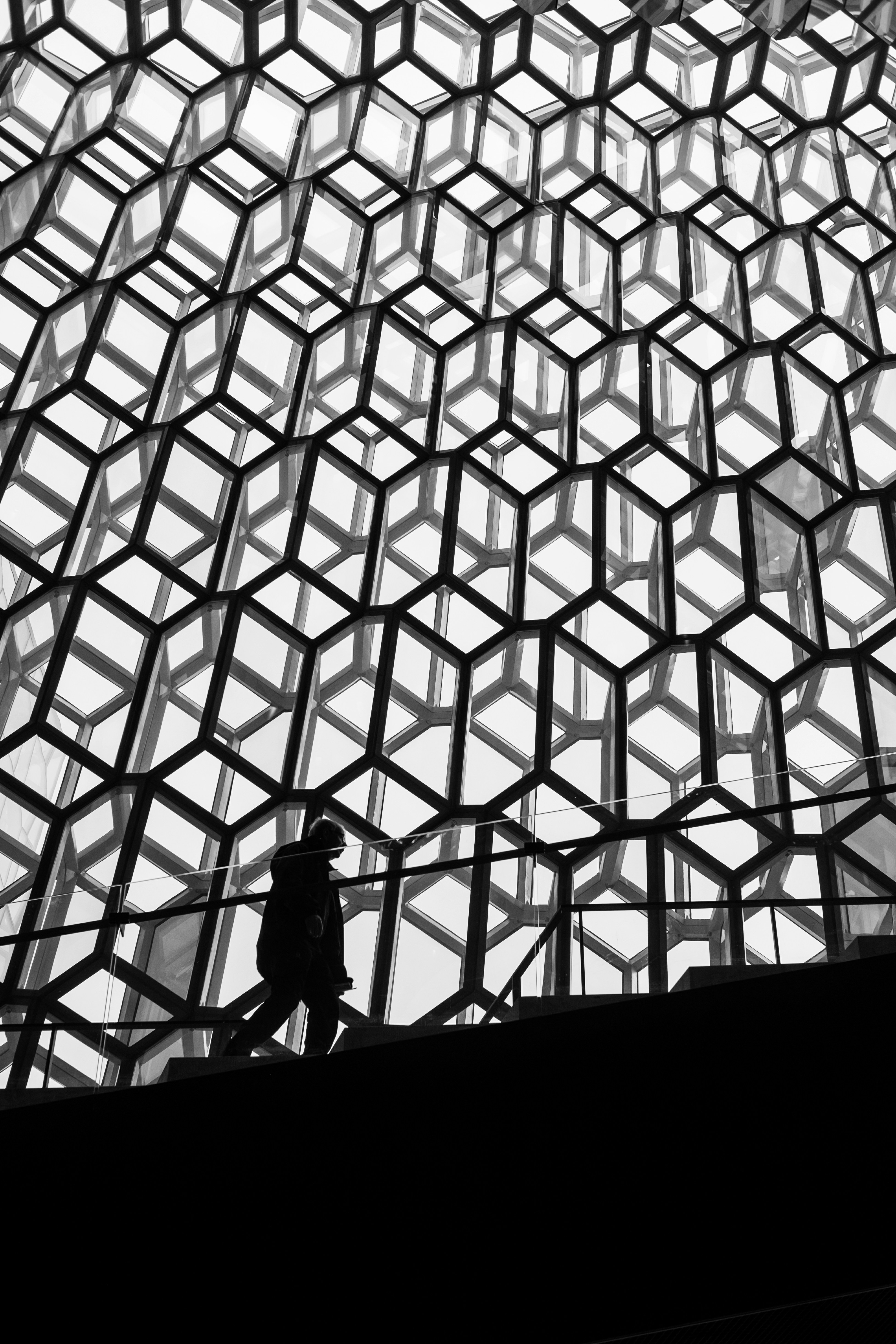 Silhouette Traversing a Hexagonal Glass Mosaic