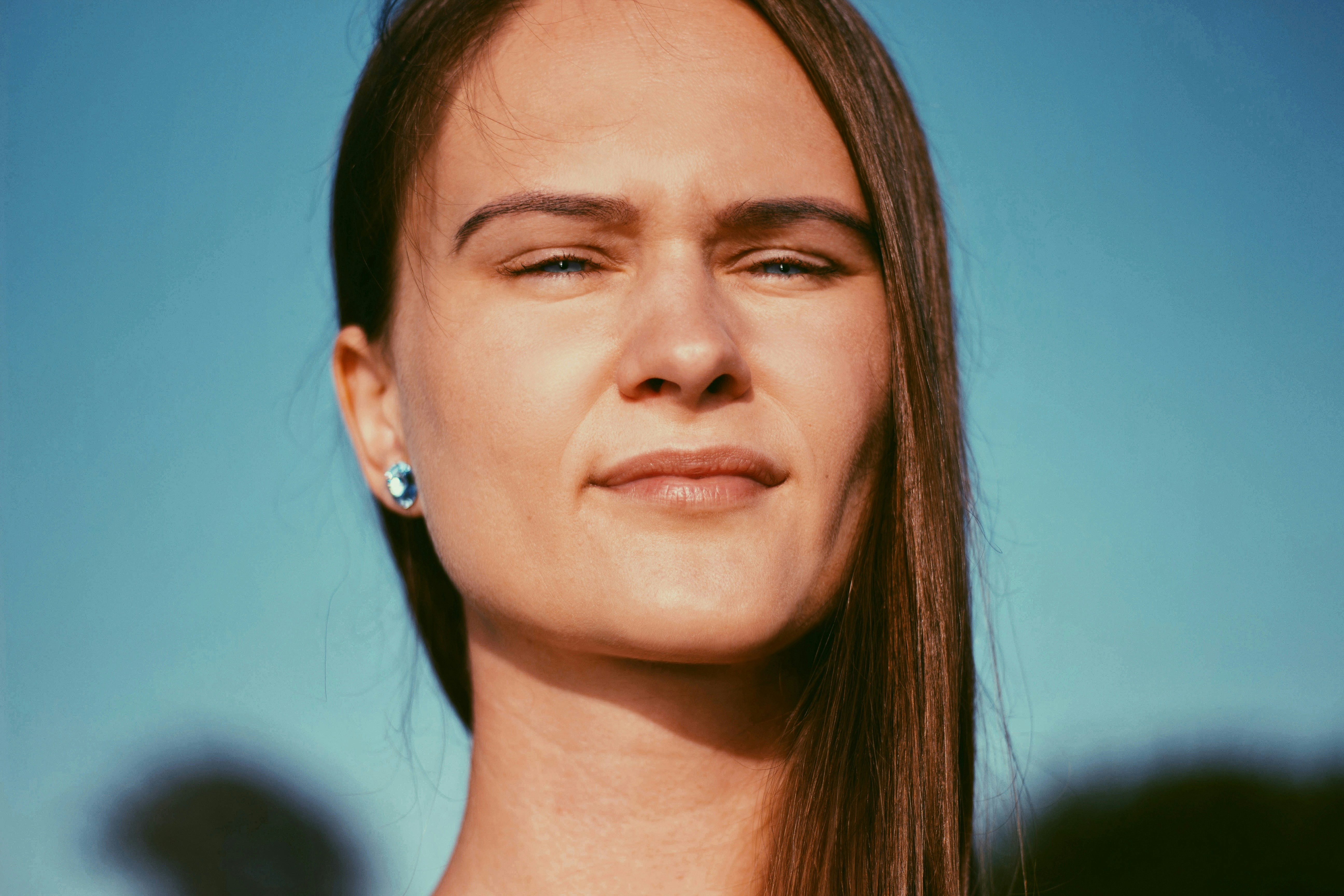 Gaze in Cerulean Light: Portrait Under an Open Sky