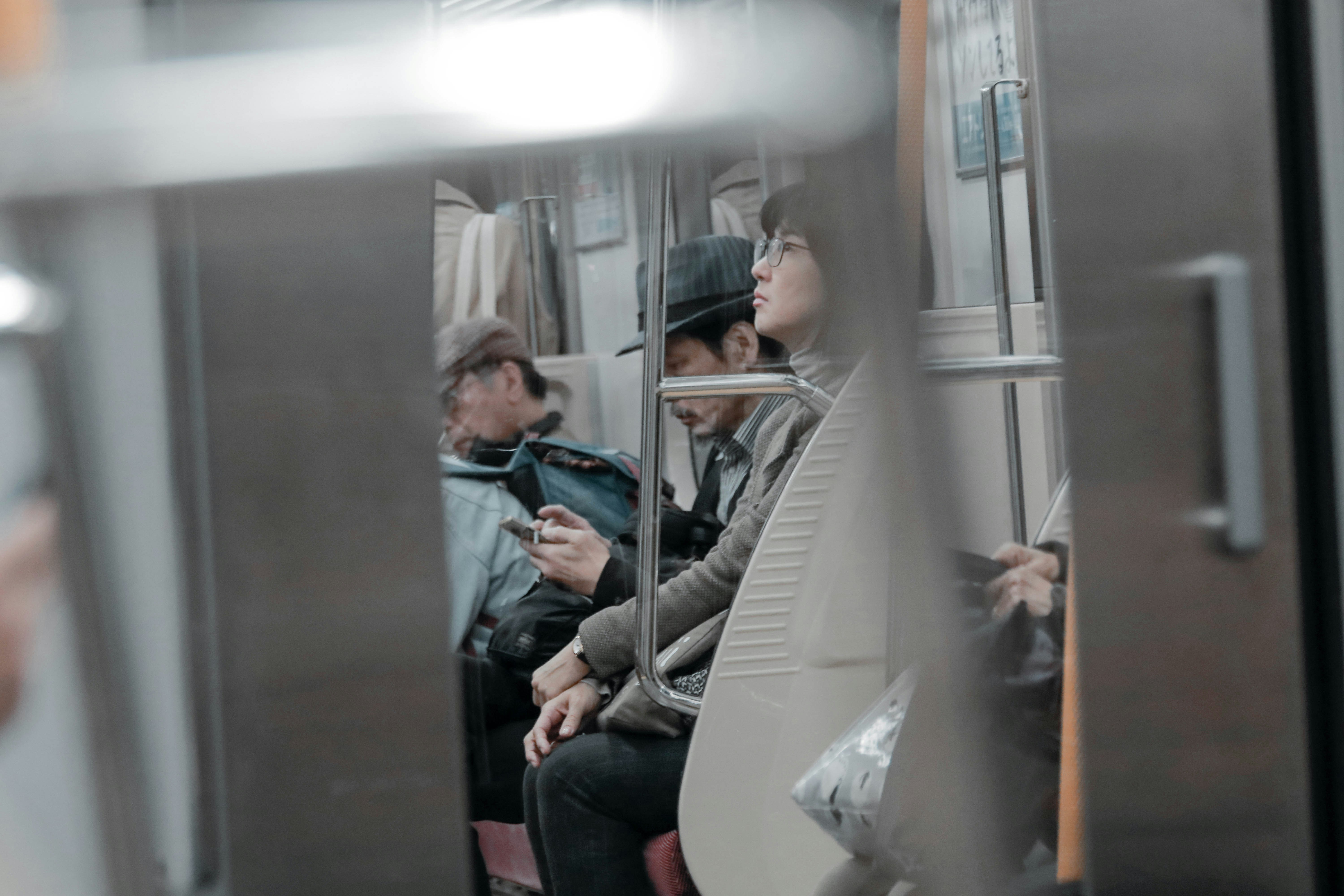 Shallow focus photo of people riding train photo – Free Grey Image on ...