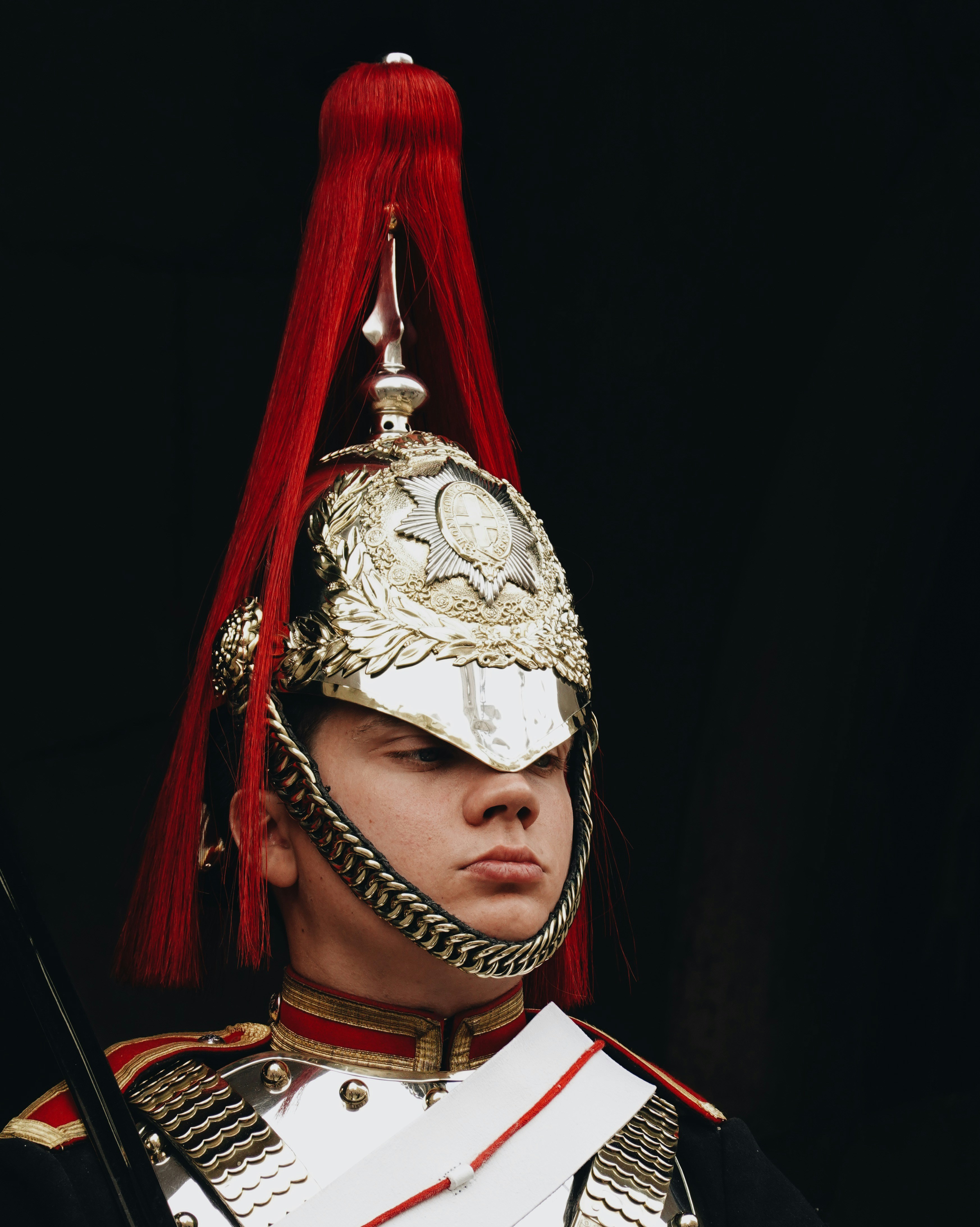 Crimson Plume Portrait: Ceremonial Guard in Elaborate Silver Helmet