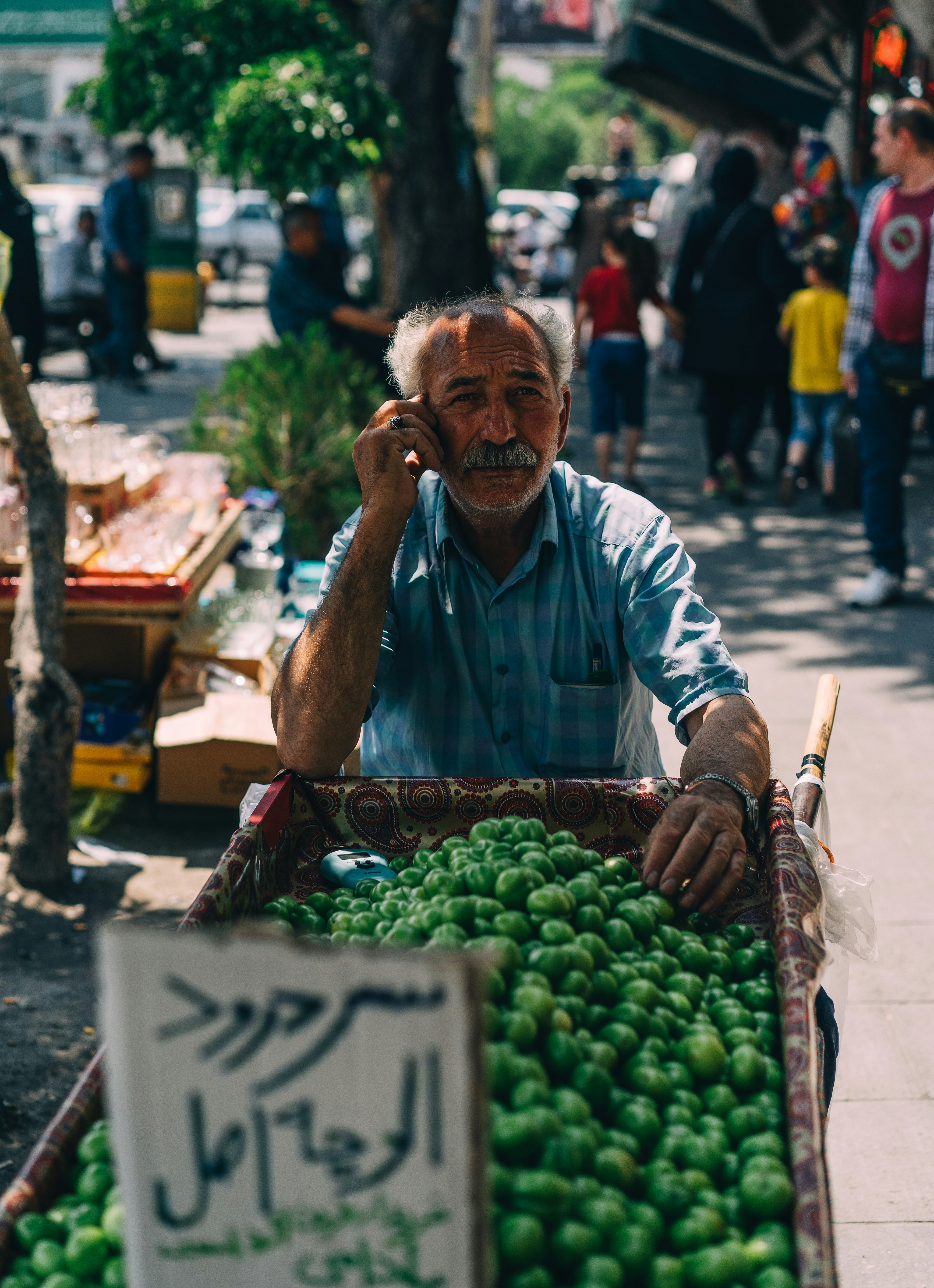 City Market Pause: A Lime Vendor Chats Amid the Foot Traffic