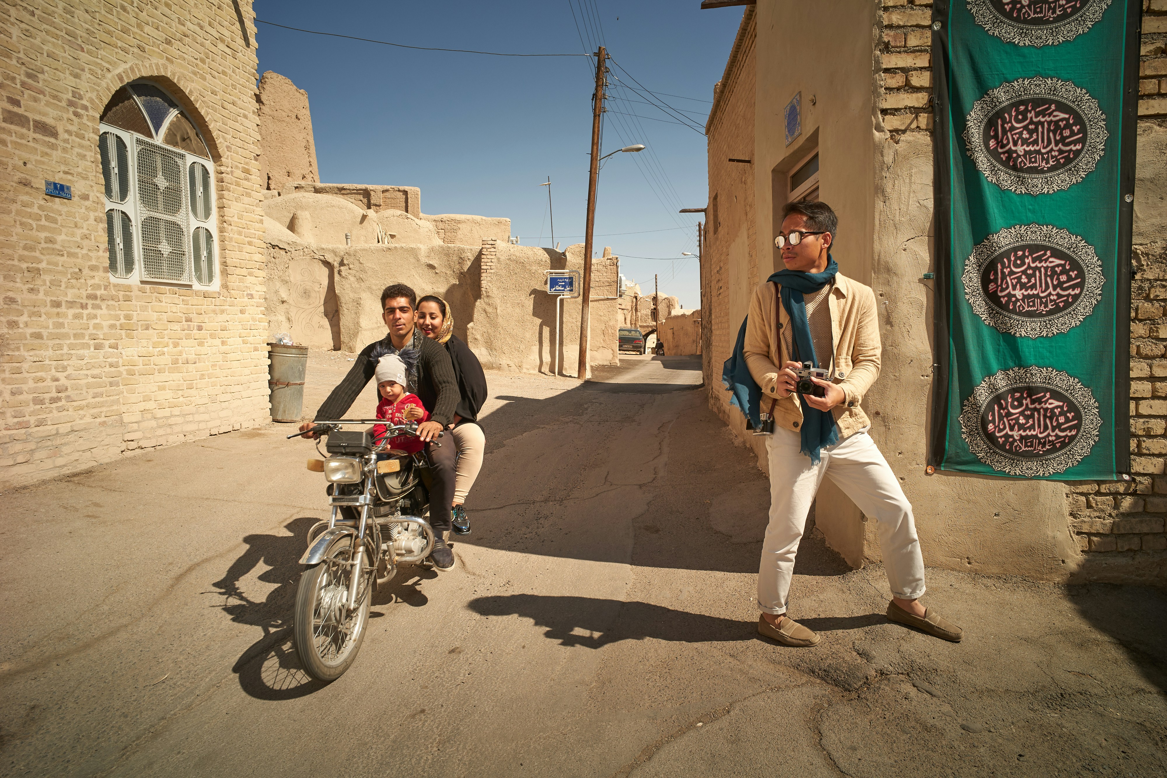 Motorcycle Run Through a Sunlit Middle-Eastern Street