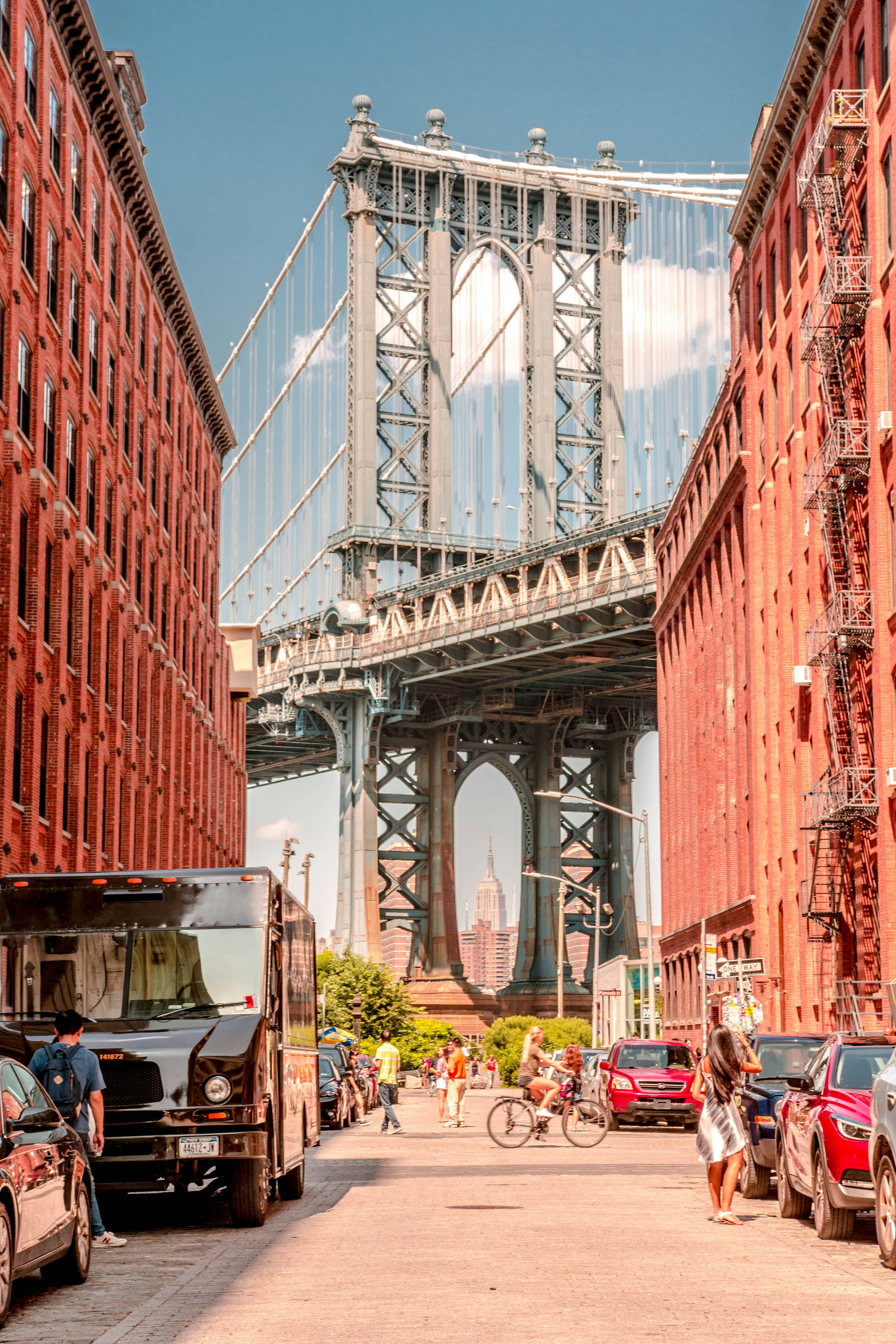 a city street with a bridge in the background