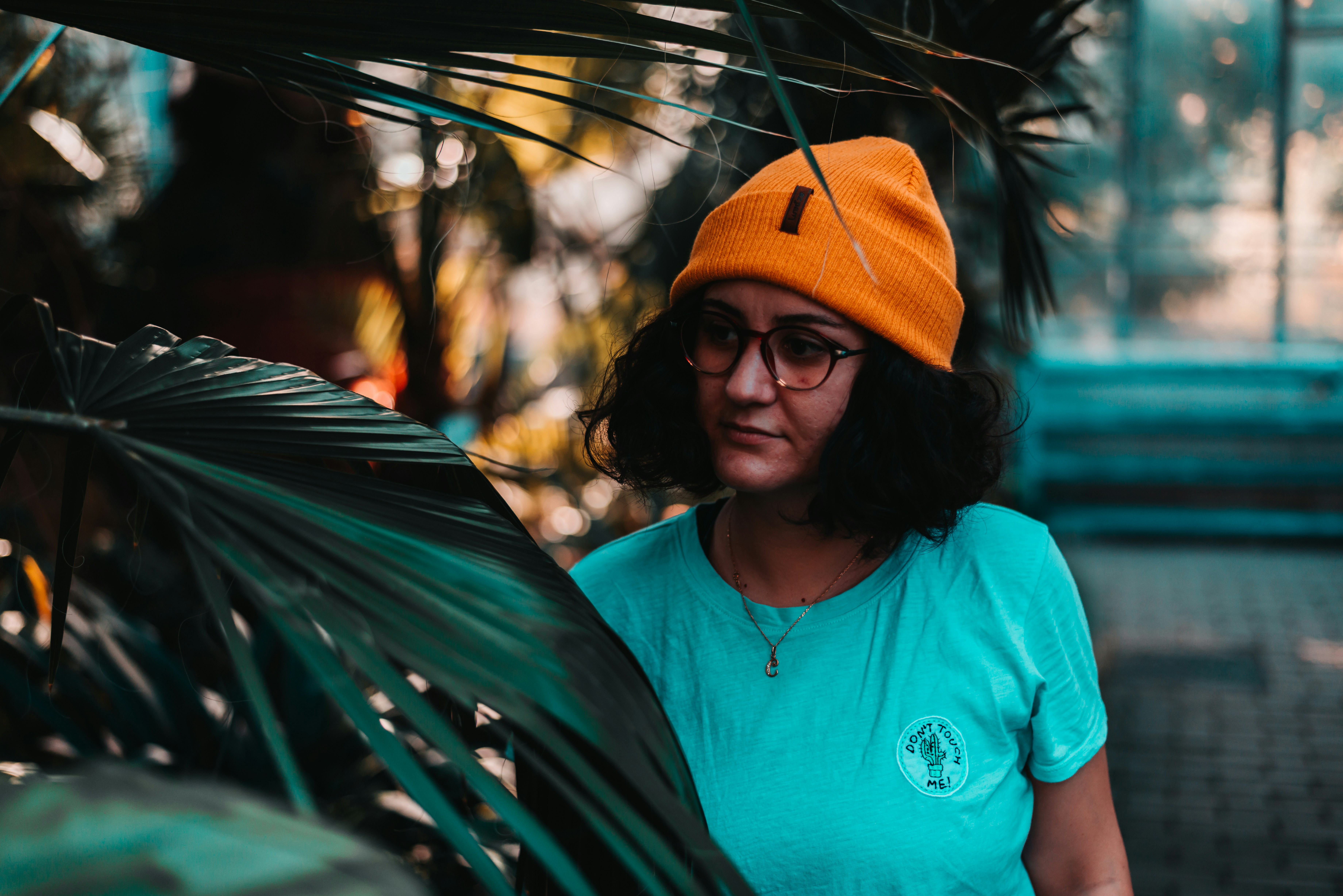 Girl looking at green plant leaves