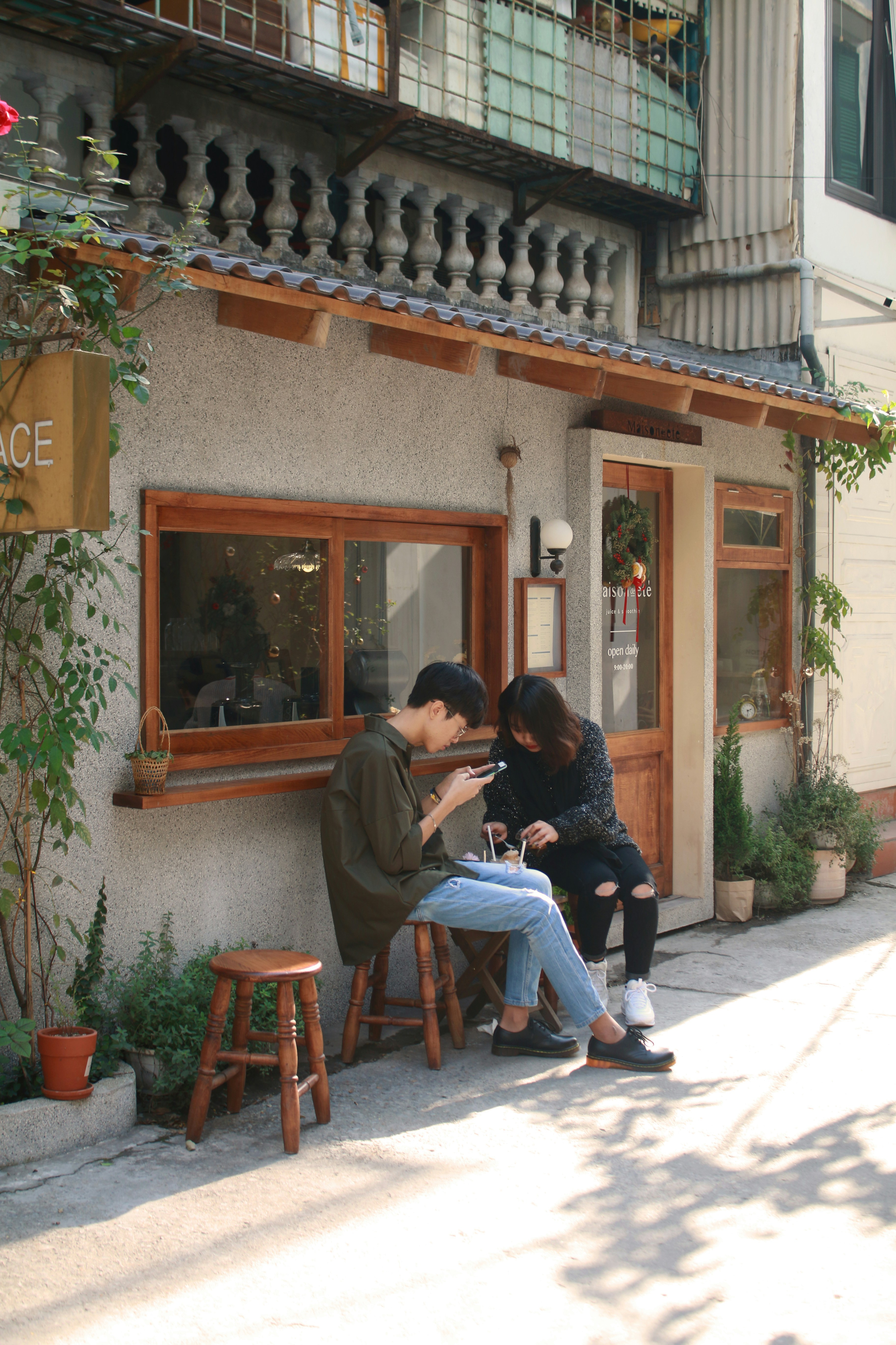 Couple sitting on stool outside photo – Free Human Image on Unsplash