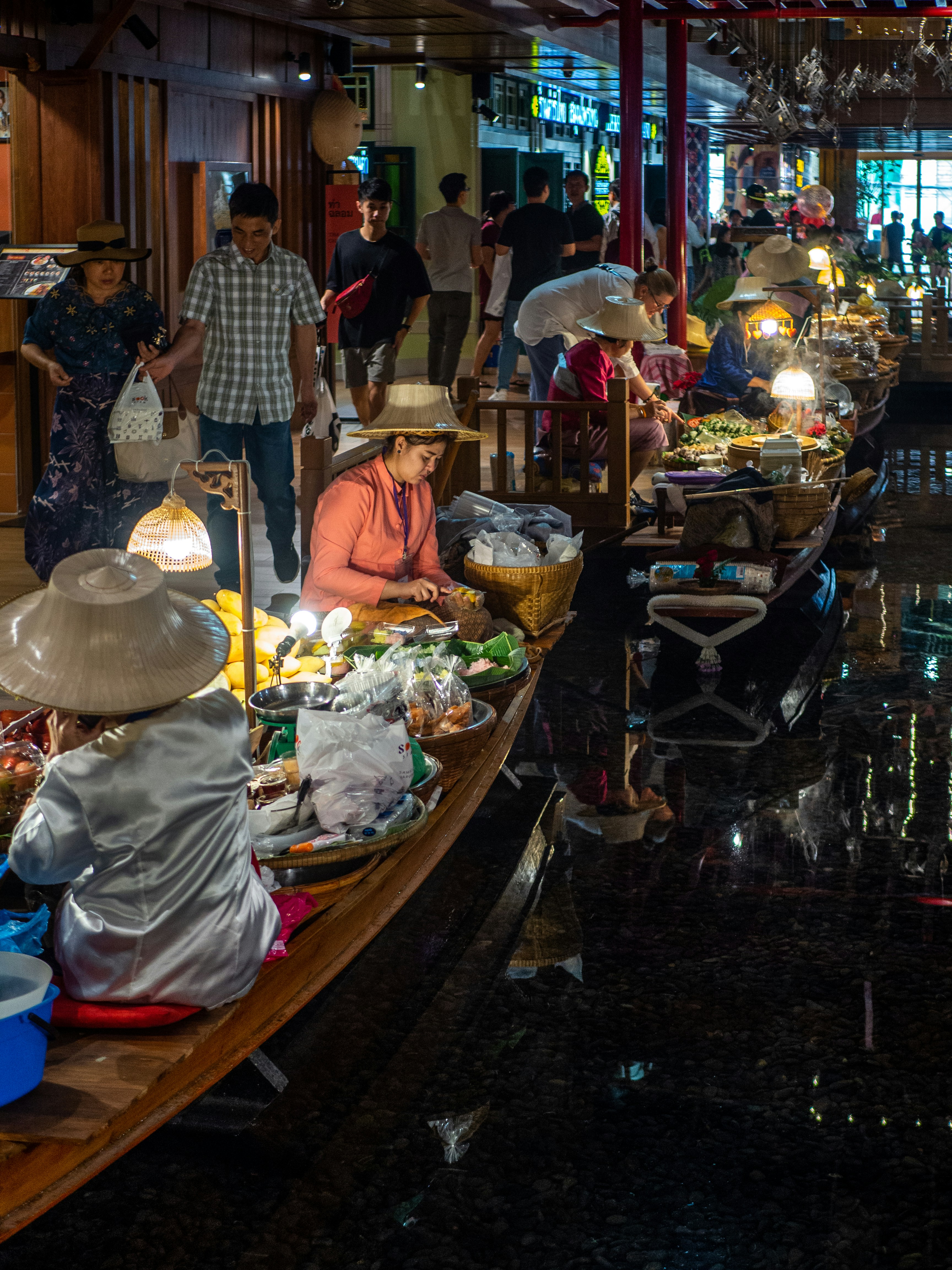 Market Boat at Dusk: A Row of Vendors and Shoppers Along a Canalside Corridor