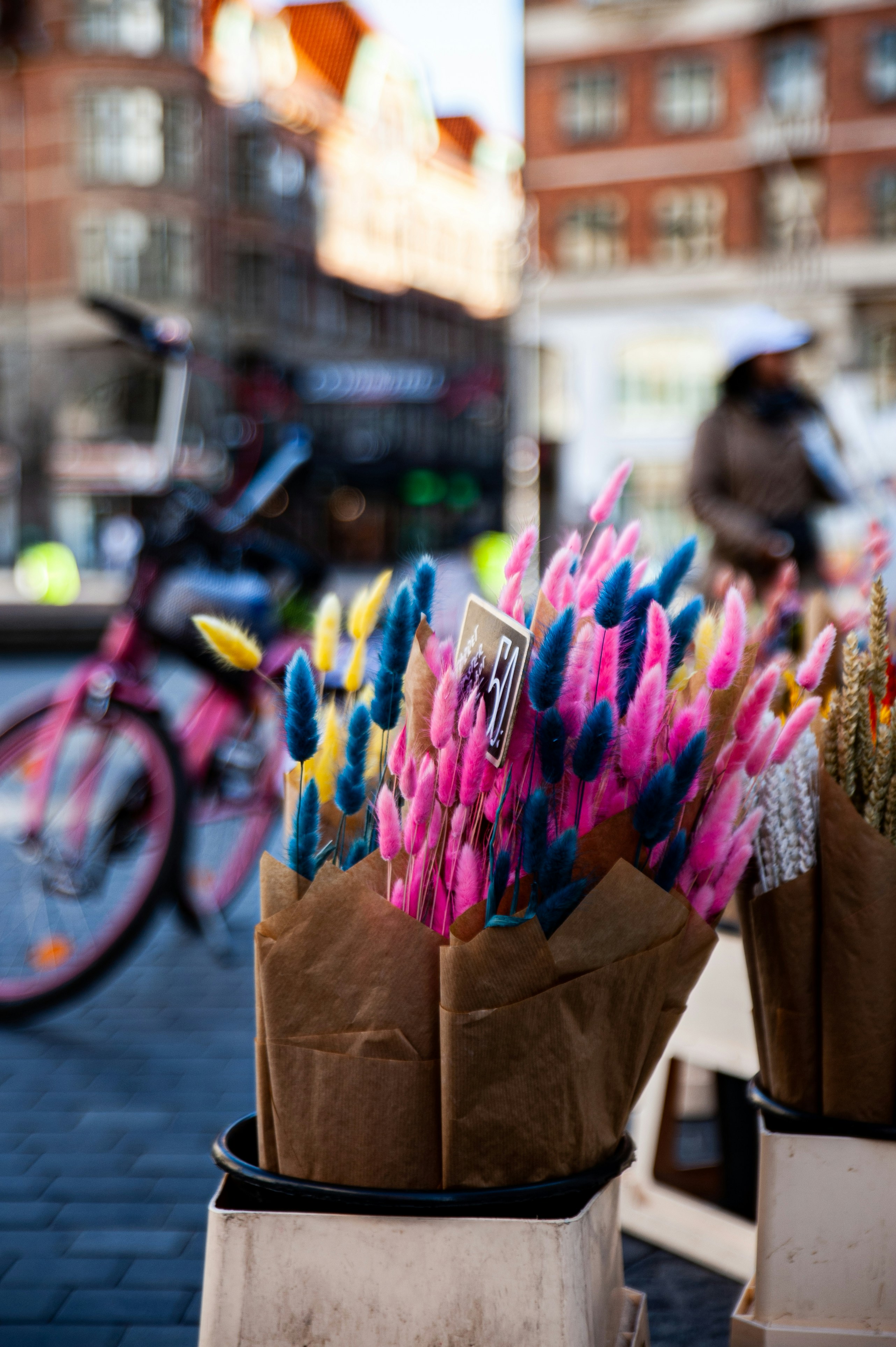 Colorful bouquet towers: candy-flossed stems in a bustling city stall