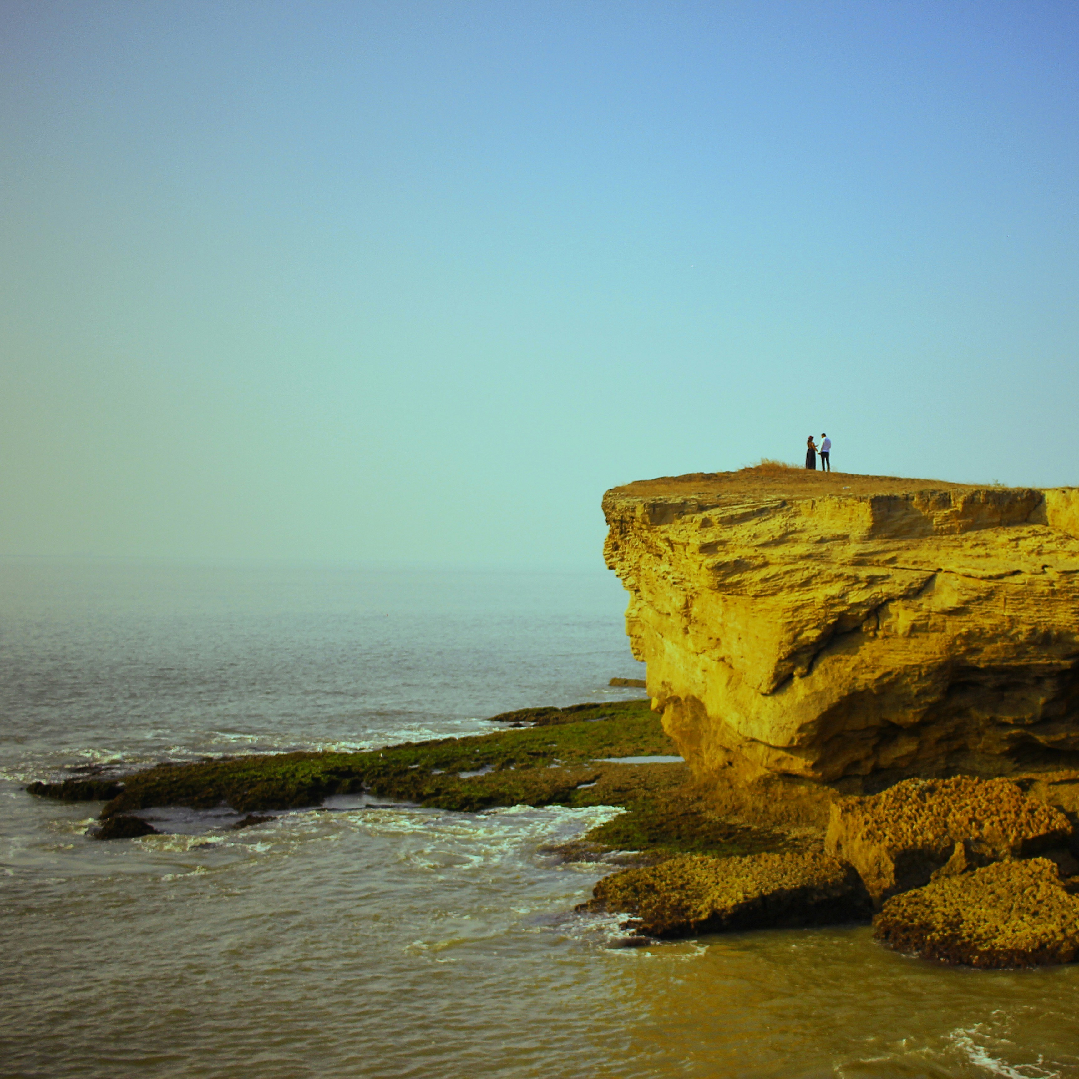Cliff Top View: Two Figures on the Golden Edge