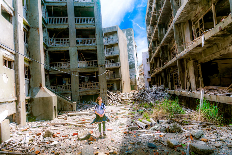 Gunkanjima is an abandoned island. Its appearance is unbelievable: surrounded by a sea wall, you will find an entire abandoned city with huge concrete buildings. Discover my adventures at Gunkanjima here: offbeatjapan.org/gunkanjima | woman wearing white and green dress surrounded by storey buildings