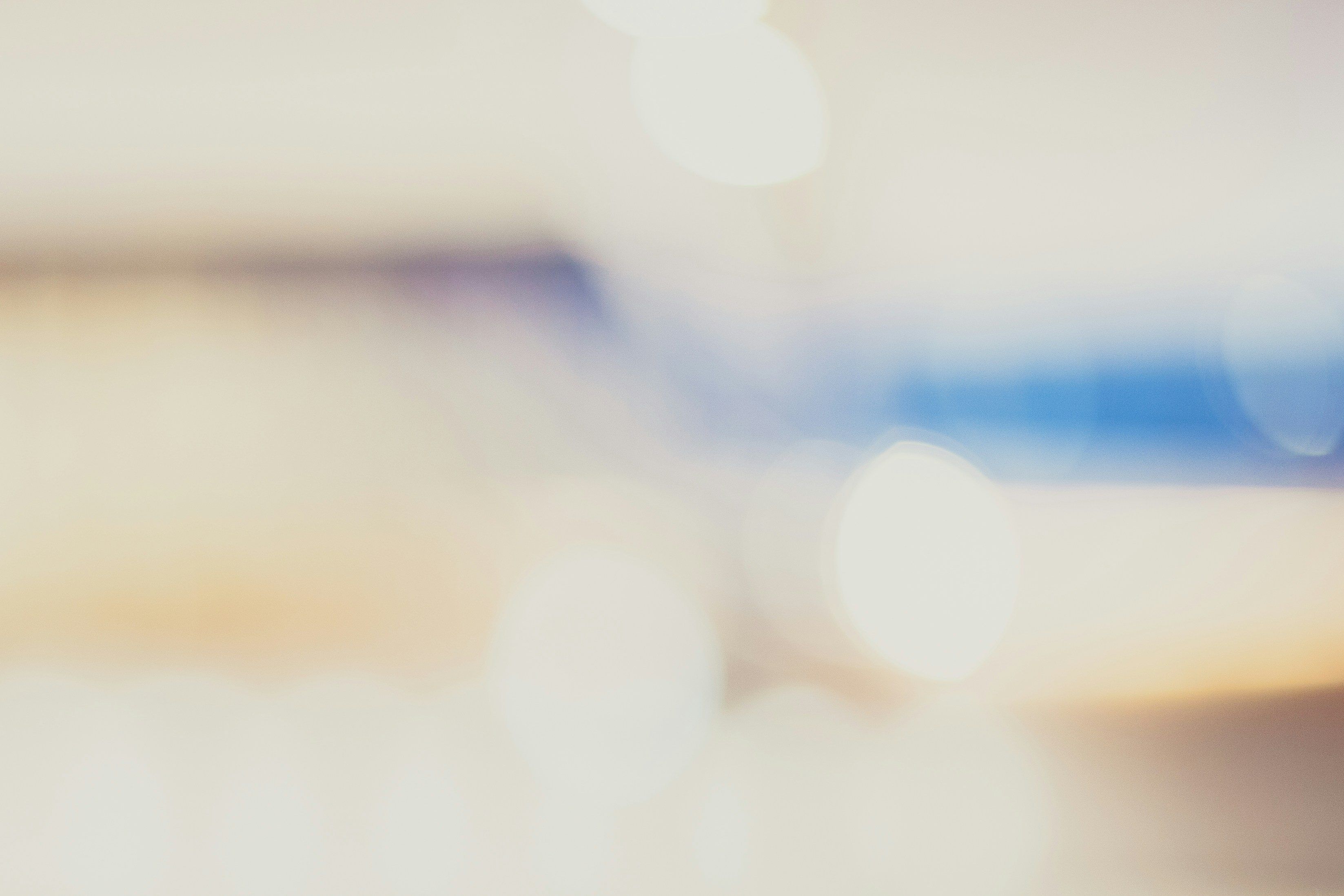 Soft, blurred lights create an abstract composition, evoking a sense of movement and tranquility.