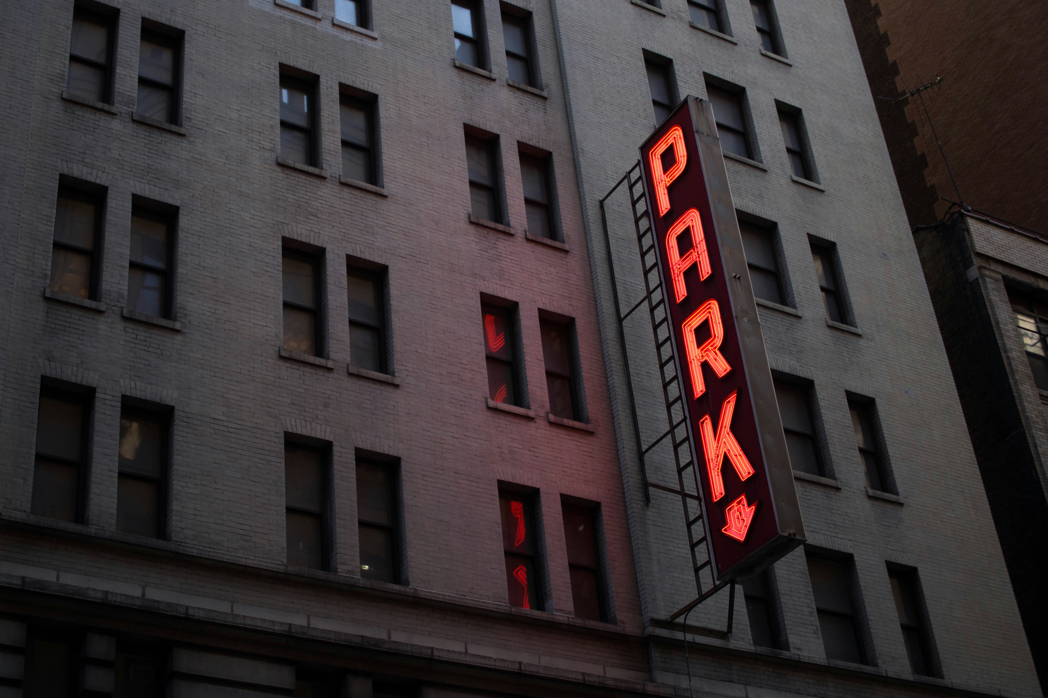 Red Park light signage on gray concrete building photo – Free Sign ...
