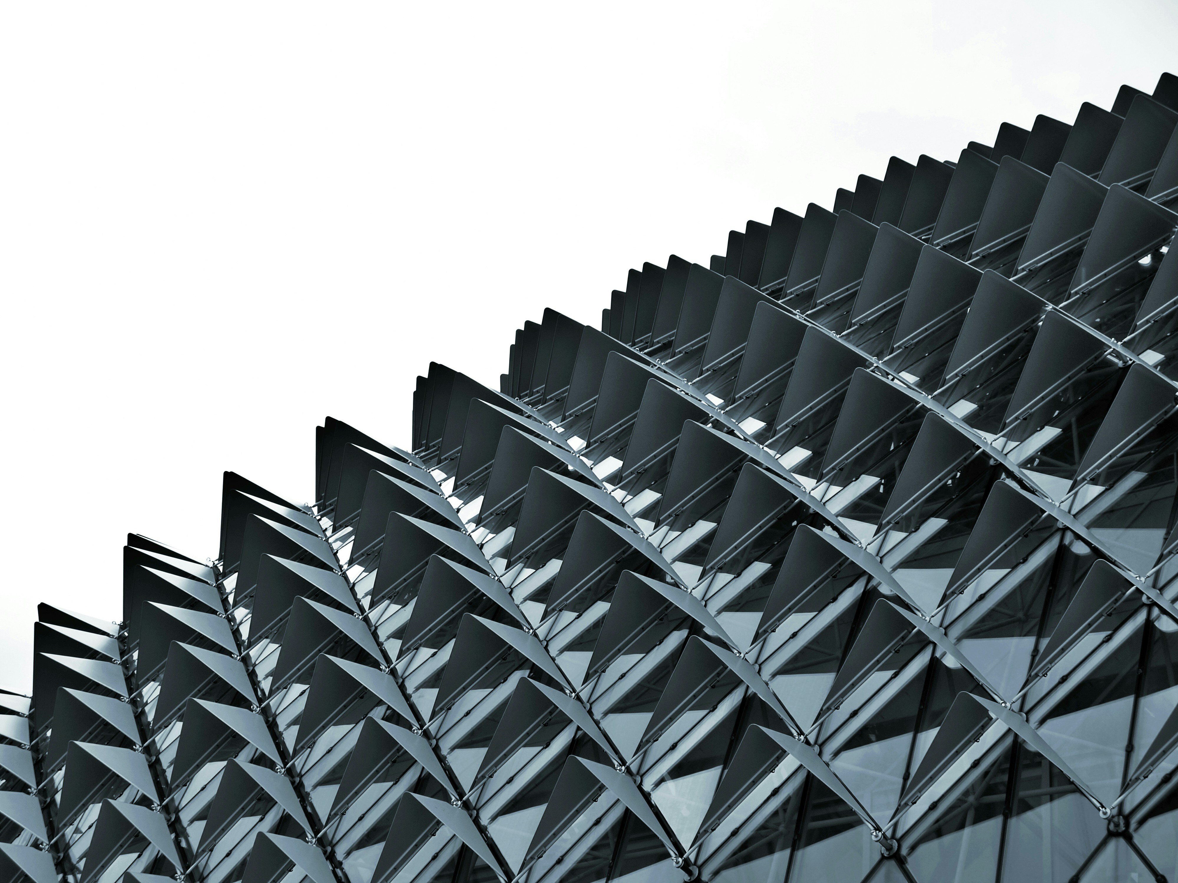 Close-up of a modern building's facade showcasing intricate, overlapping panels that create a dynamic visual effect.