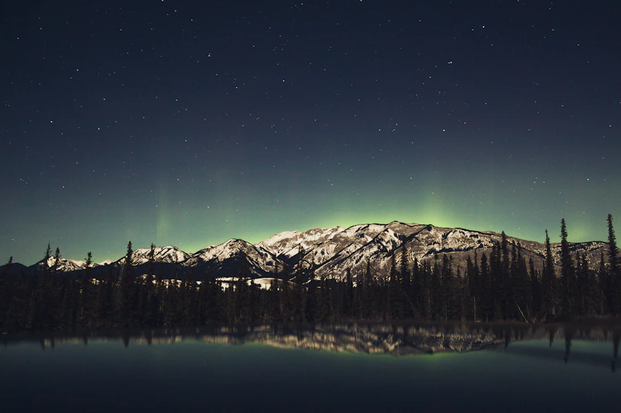 Northern lights over a lake | reflecting photography mountain