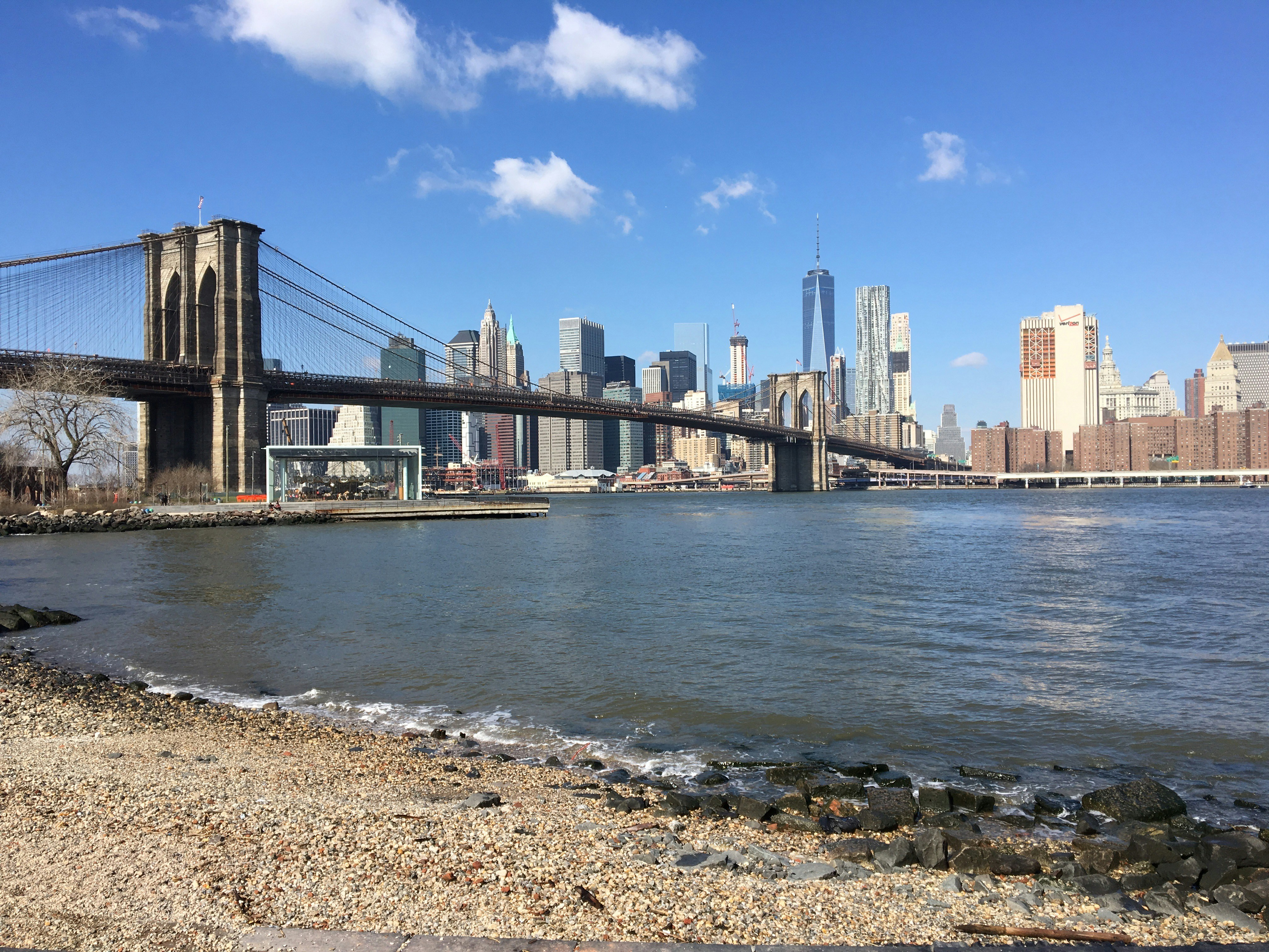 East River in Focus: Brooklyn Bridge Framing a Bright Manhattan Skyline