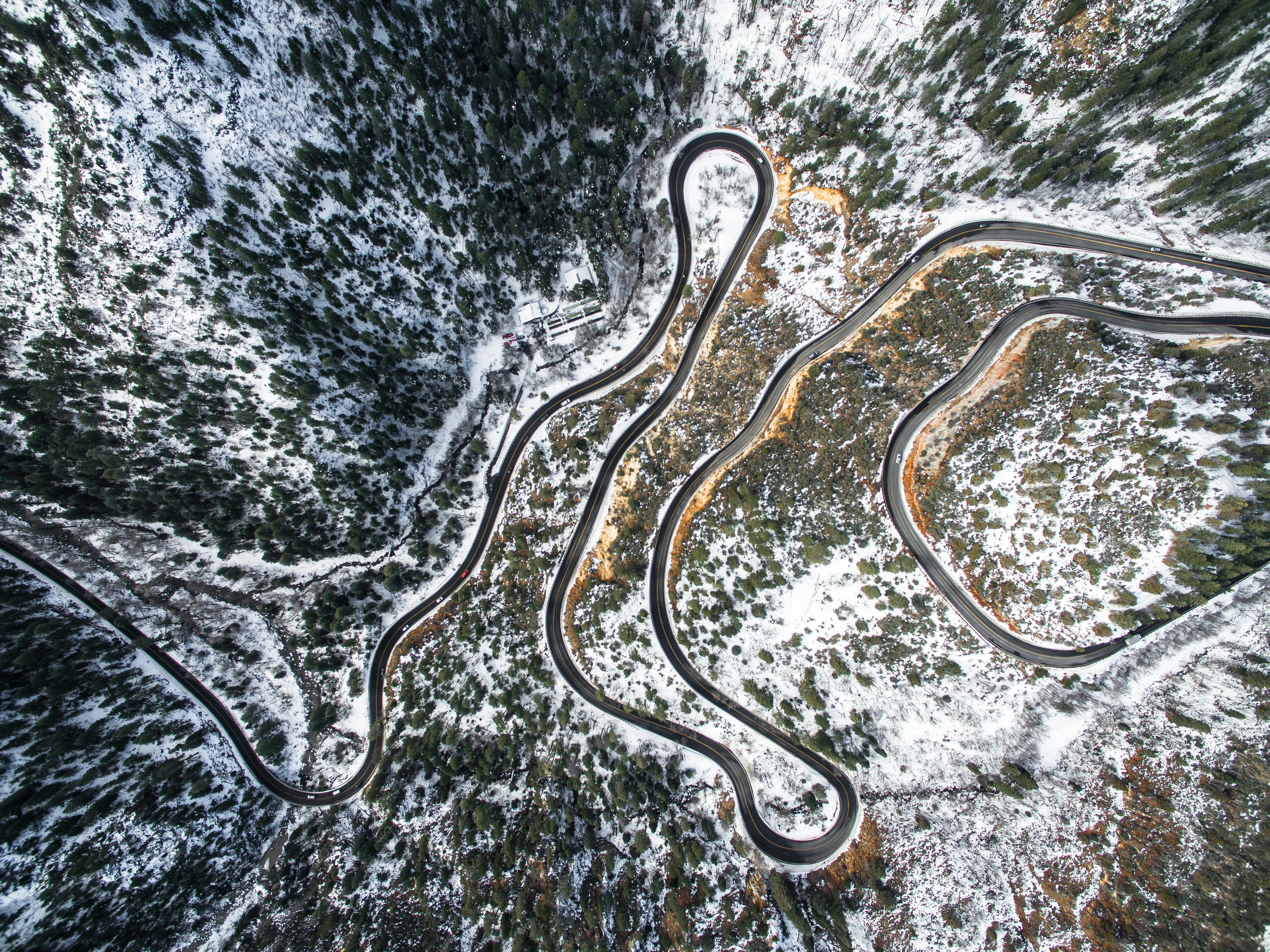 A beautiful winding road near Sedona, AZ. Extreme rush, cold batteries and turned off phone during the flight are the factors that make this photo so special to me. | bird's eye view of highway in forest