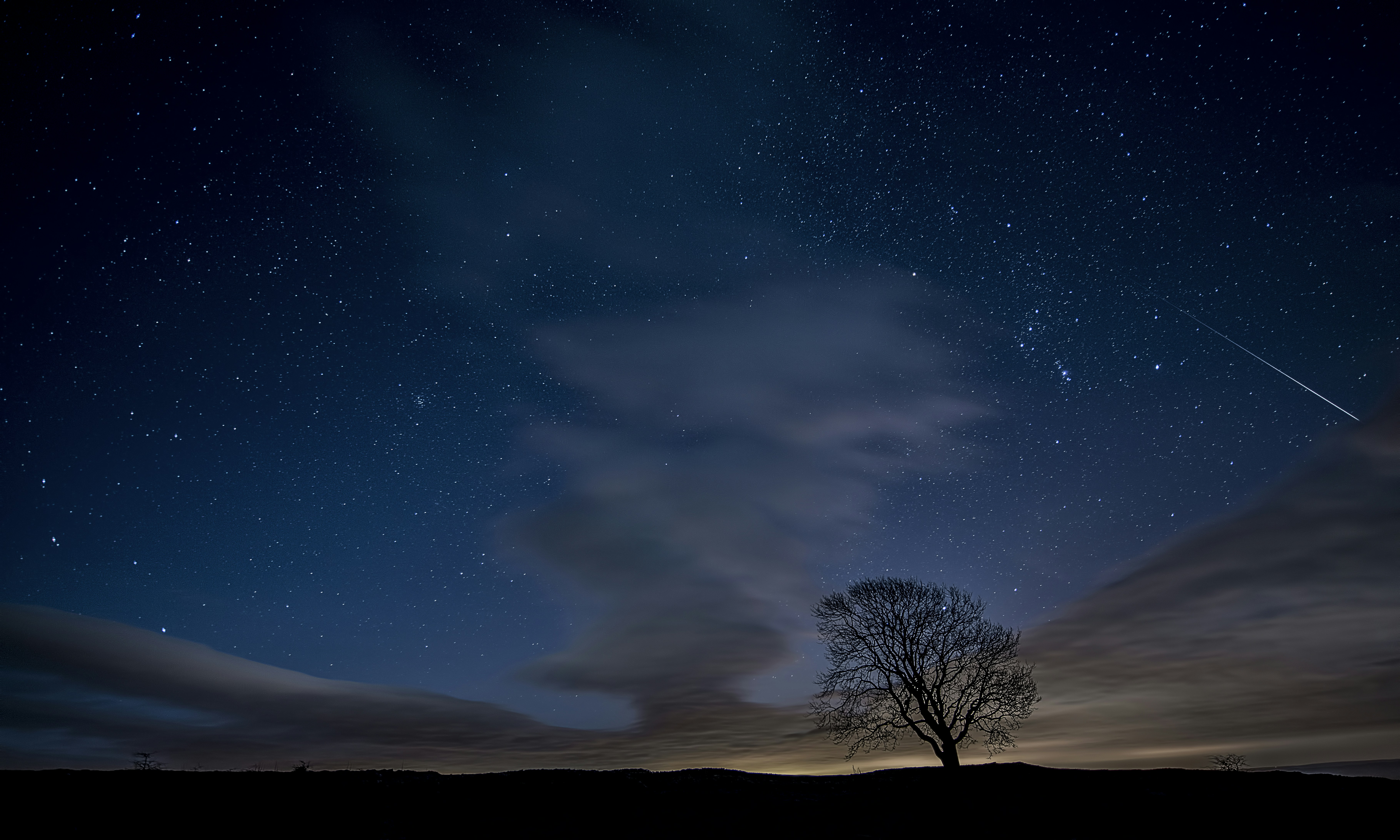 Malham Cove astrophotography | silhouette photo of trees during nighttime