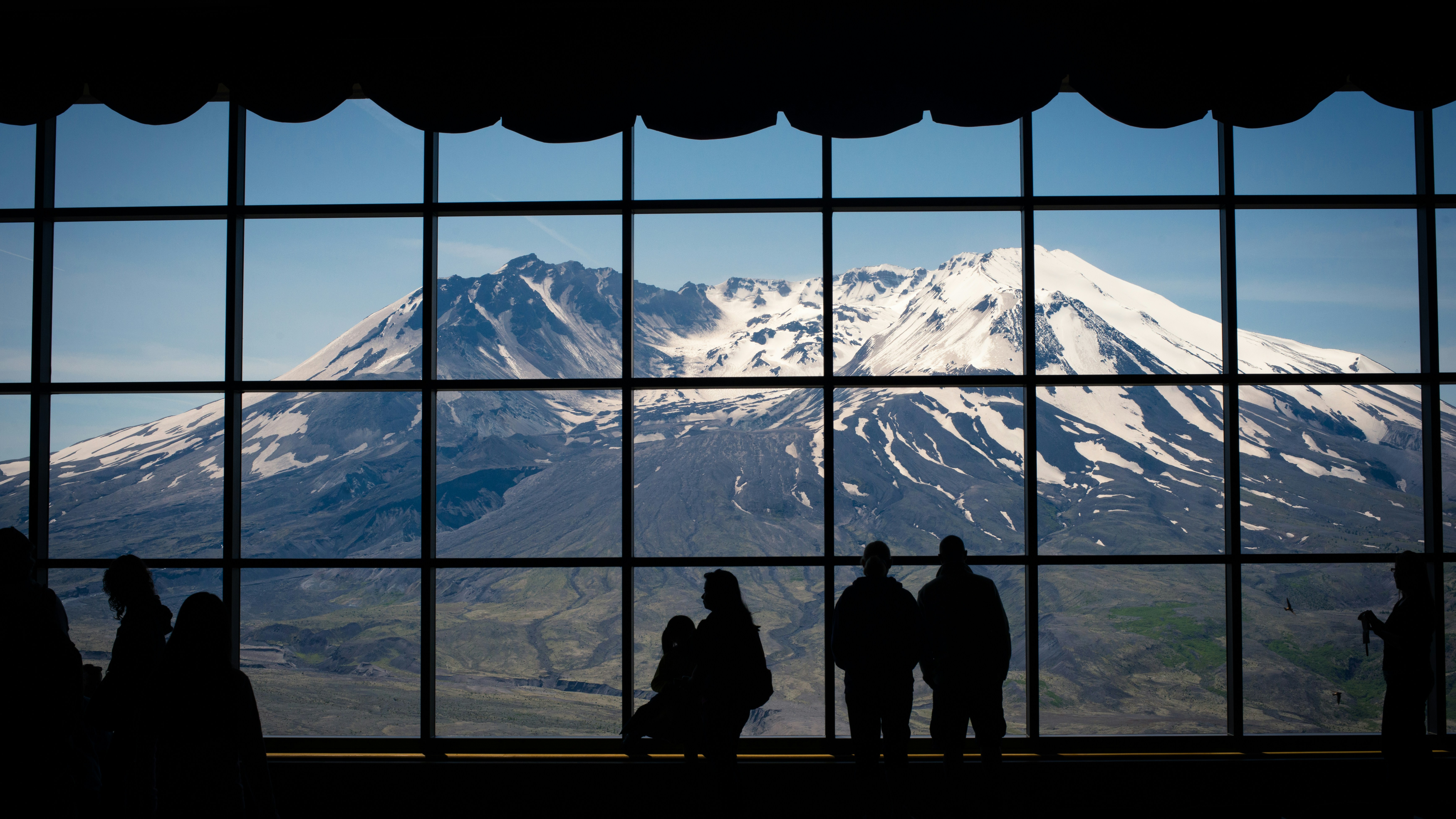 One of the most dramatic museum display reveals I’ve ever seen; after the video presentation at the Mt. St. Helens visitor center detailing the volcano’s destructive power, the screen lifts to show this window to the mountain itself, and that what you thought was a wall, was not a wall at all. Mall. Call. Fall. Brawl. Hooray for random alliteration. | silhouette of person standing near glass window