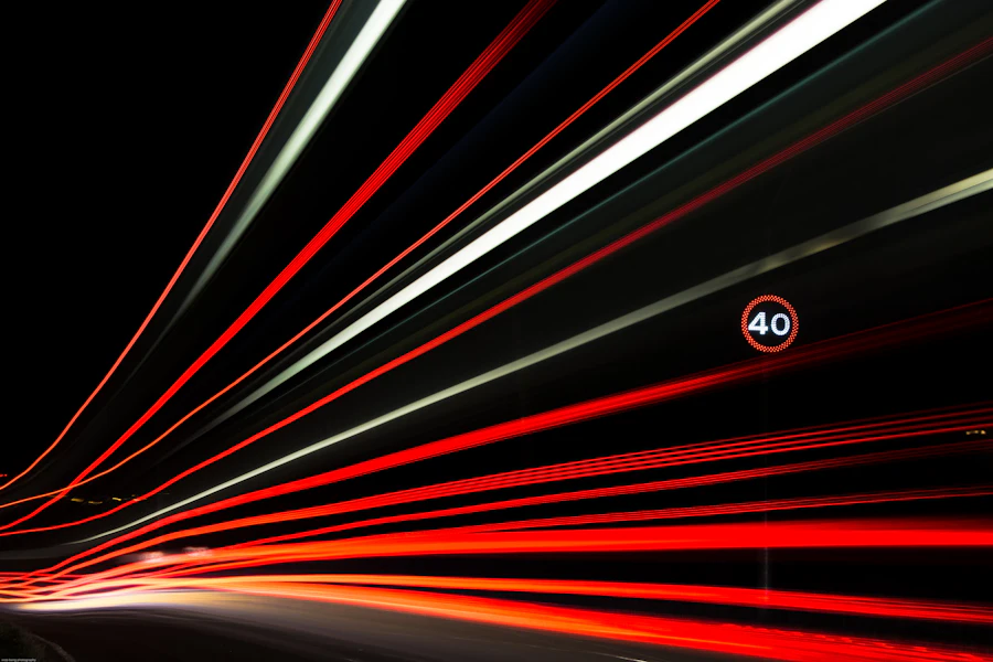 In their haste, cars and a bus ignore the 40 mph speed limit. | long exposure photography of red and white lights