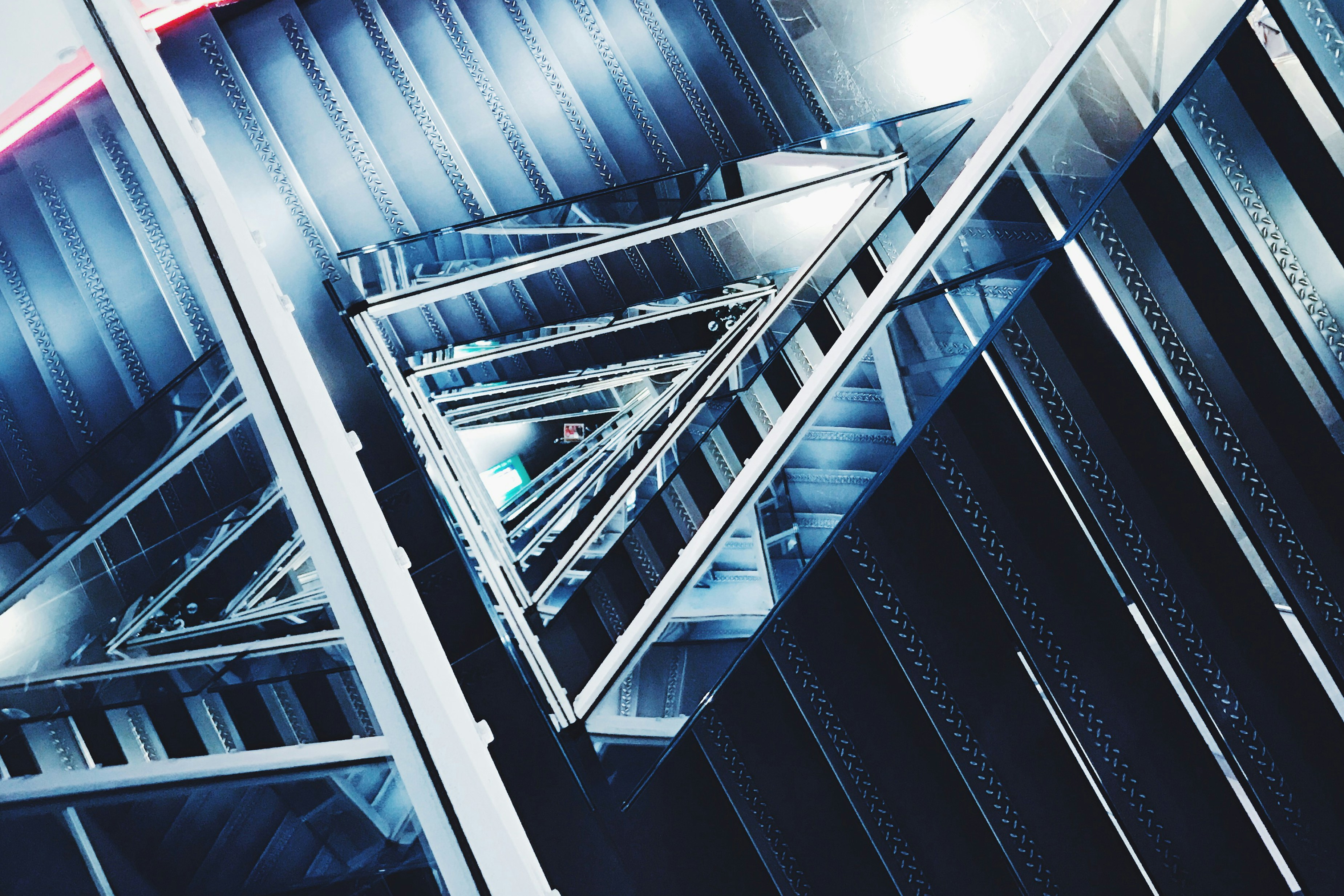 Metallic spiral staircase viewed from above, creating a mesmerizing geometric pattern.