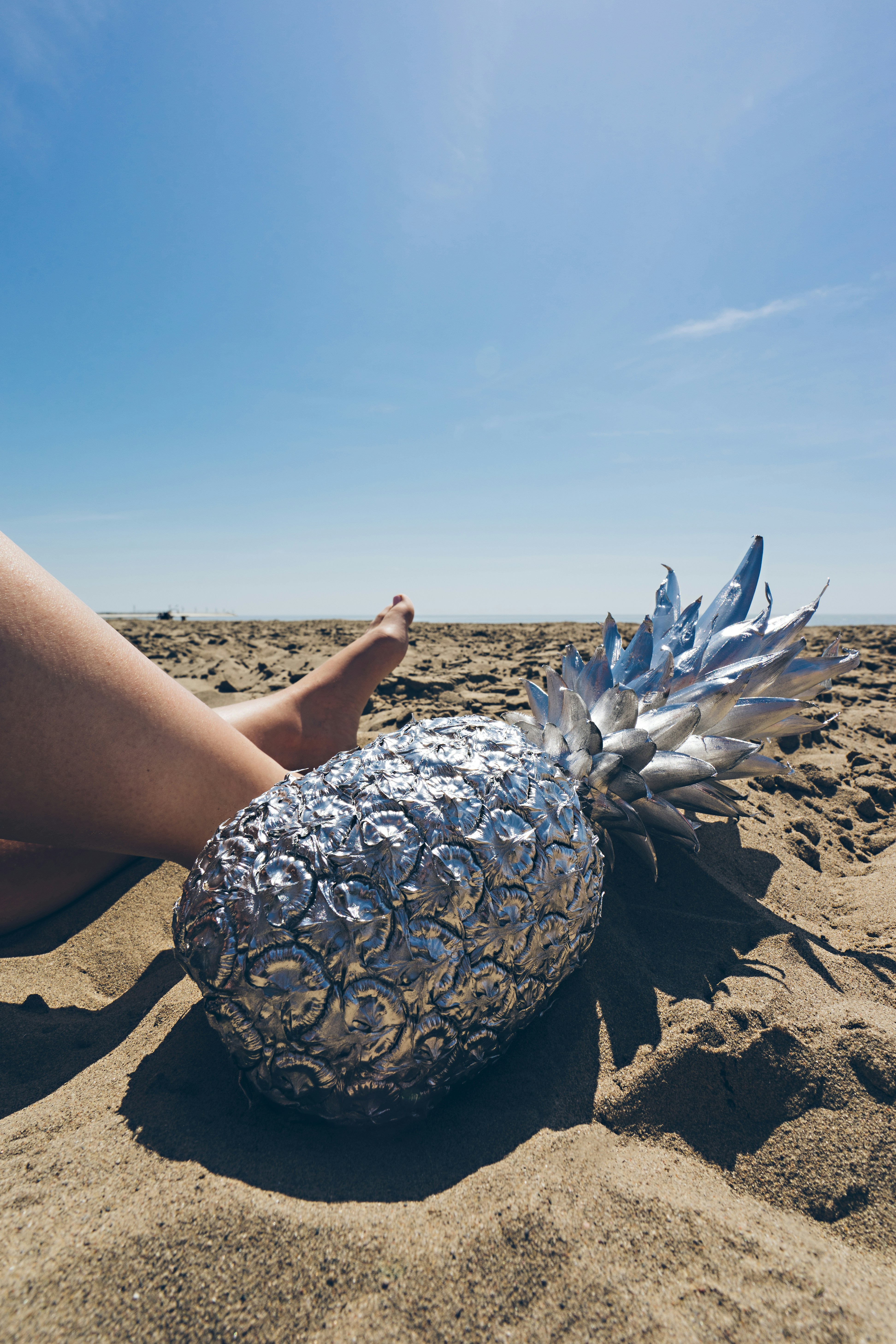 Chrome Pineapple Lounges on a Sunlit Beach