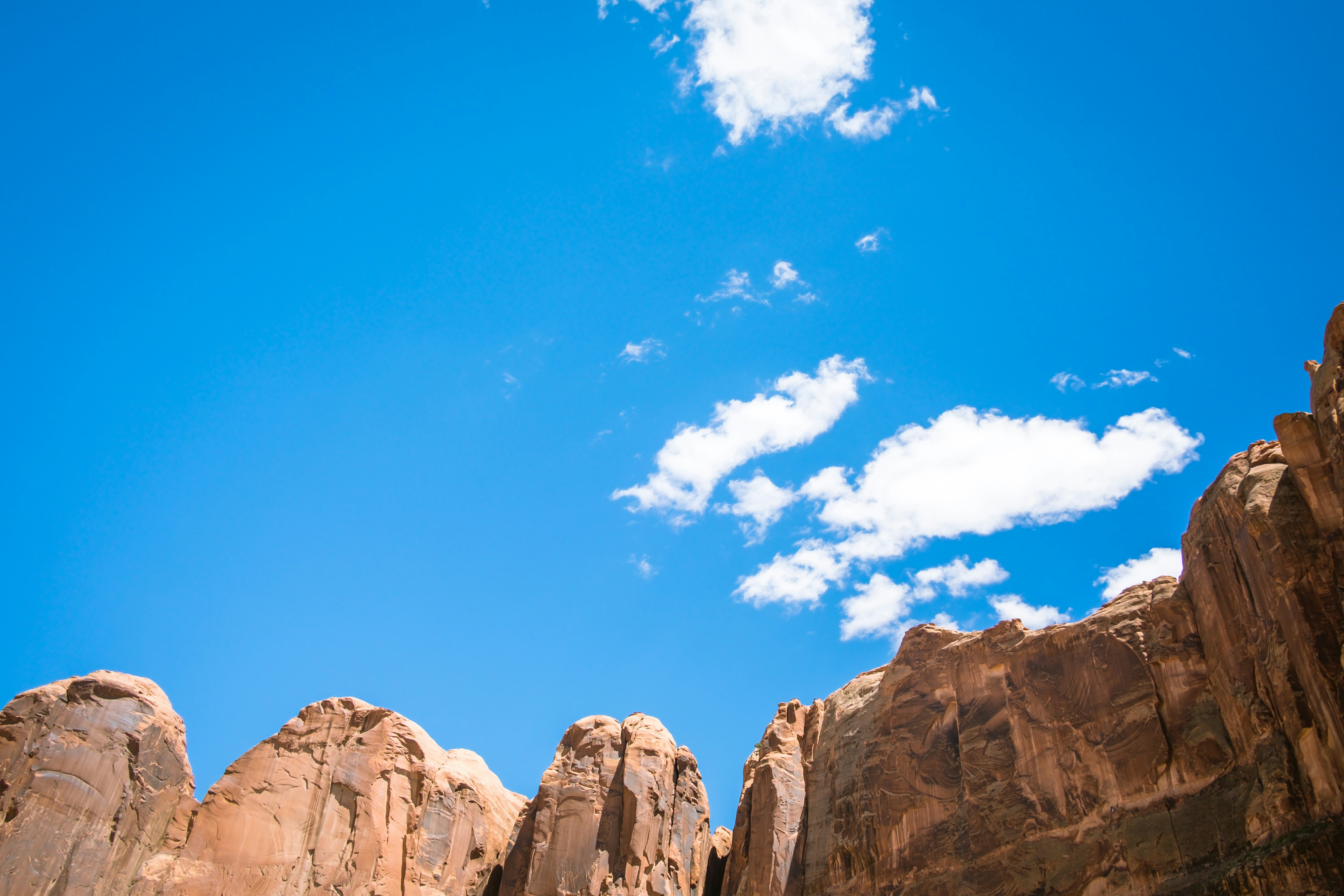 Post ride views. | brown cliff under white and blue cloudy sky
