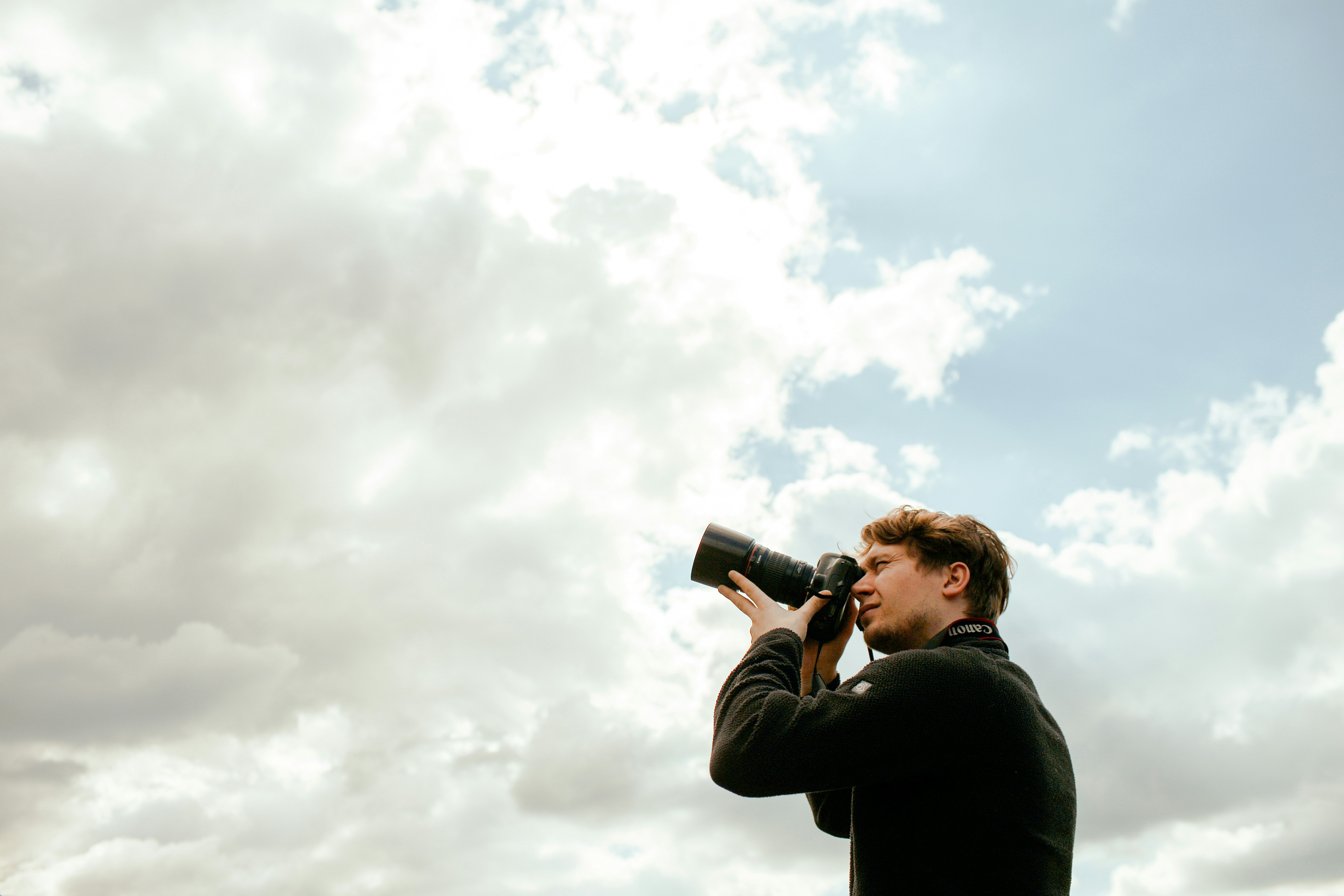 A man taking a picture with a camera photo – Free Photographer Image on ...