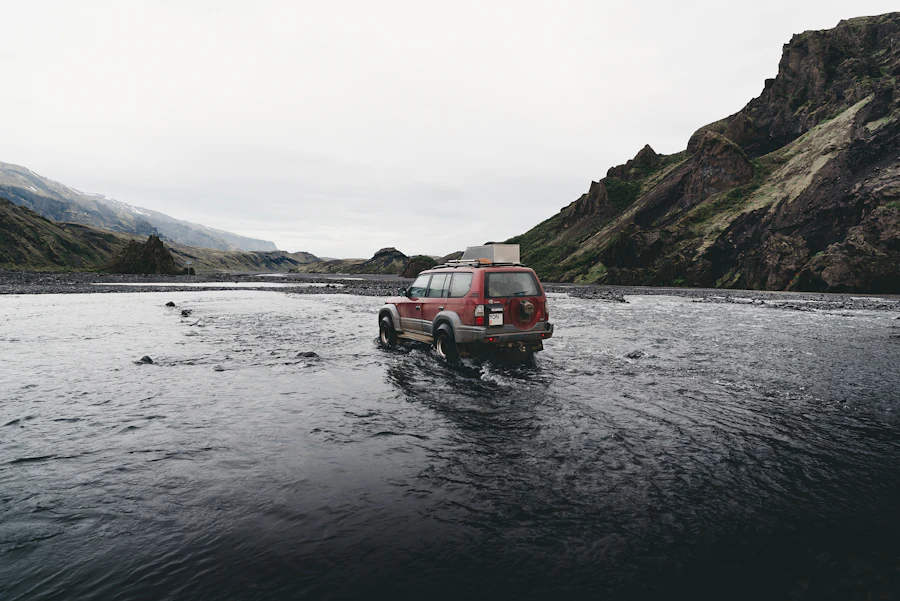 Roadtrip shared with another 4 guys from different countrys. We saw the most amazing places of this breathtaking land | red SUV on water near mountain during daytime
