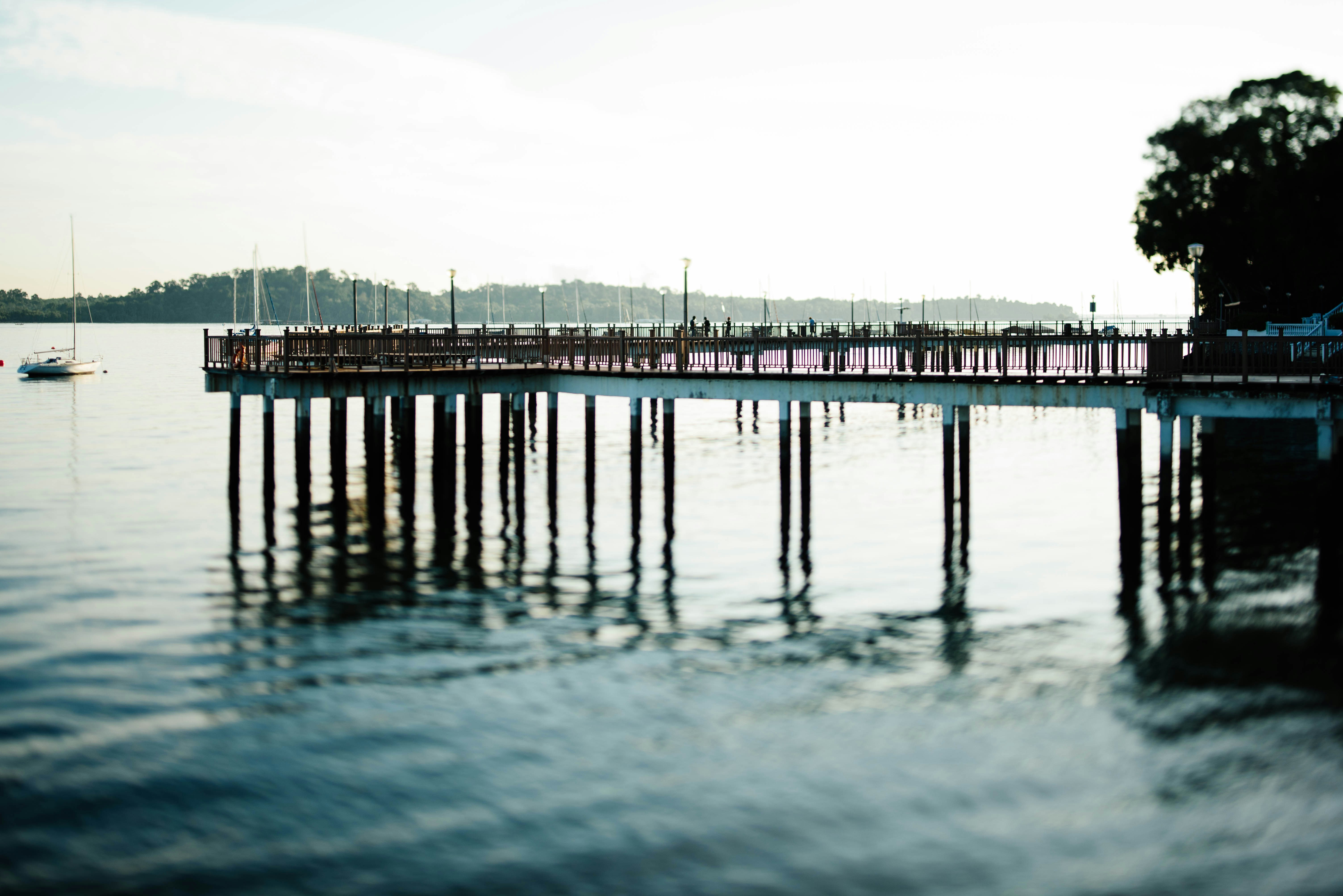 Pier of Quiet Reflections: Timber Beams Reaching Across a Glassy Lake