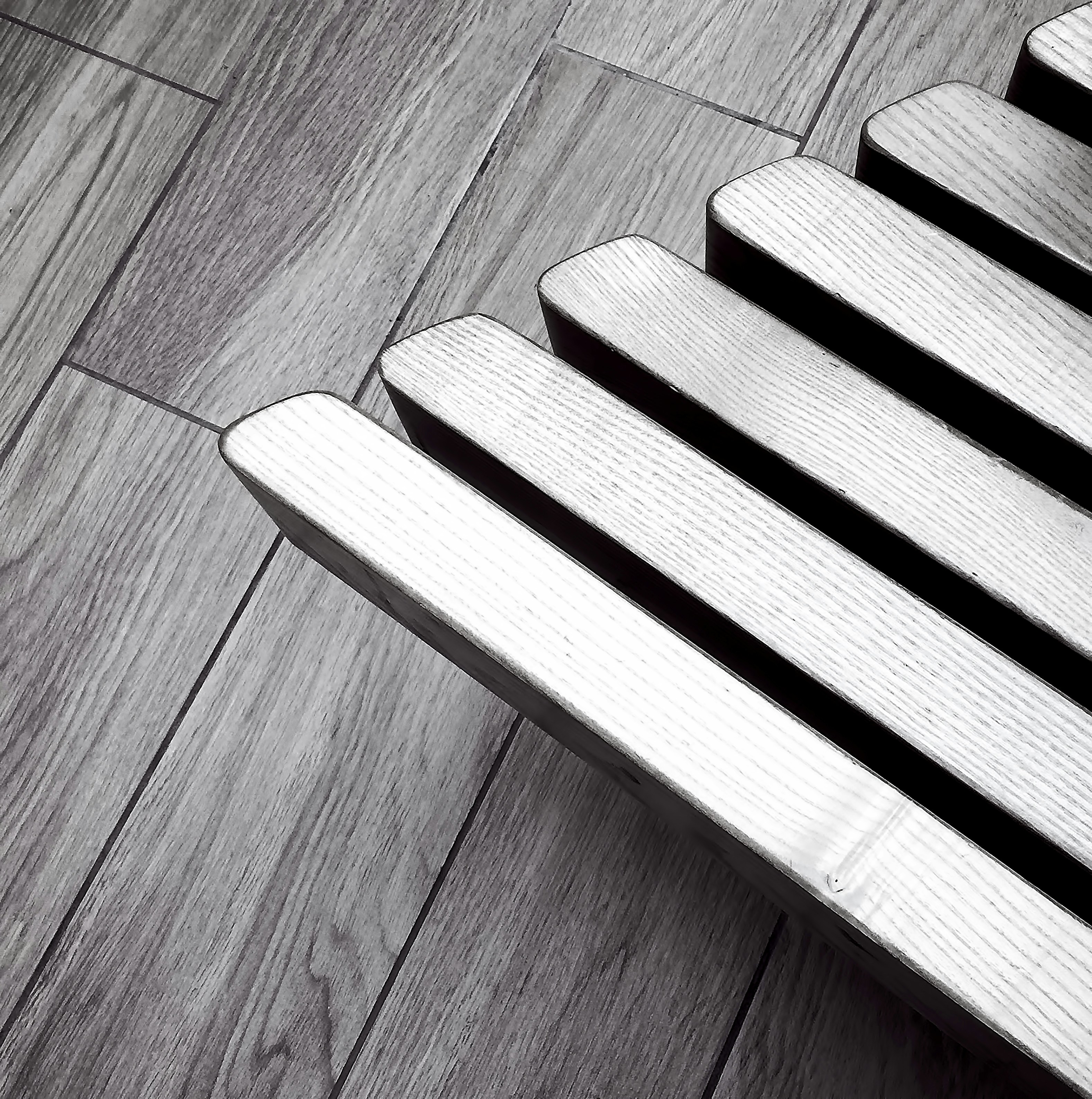 Monochrome Rhythm: Parallel Slats on a Wooden Stage