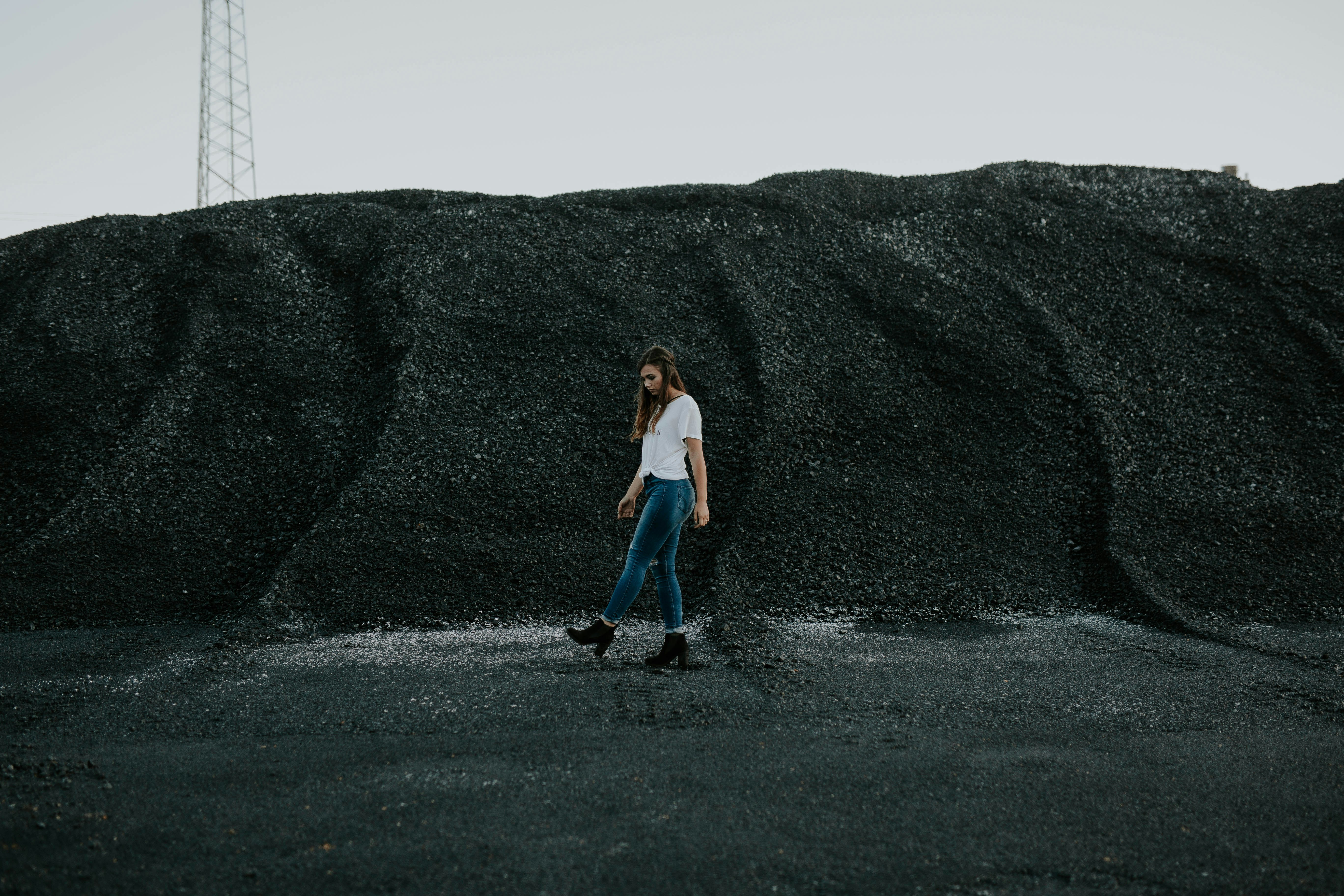 Walker on a Velvet Slope: A Solo Moment Amid Industrial Gravel