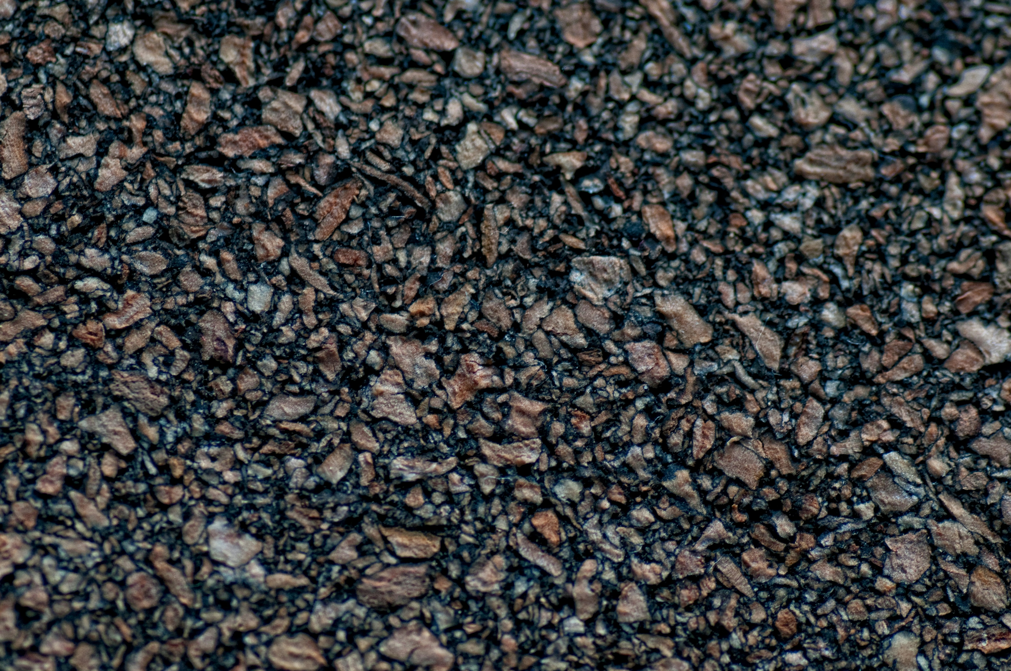 Close-up of a textured surface with dense, varied cork granules in earthy colors.