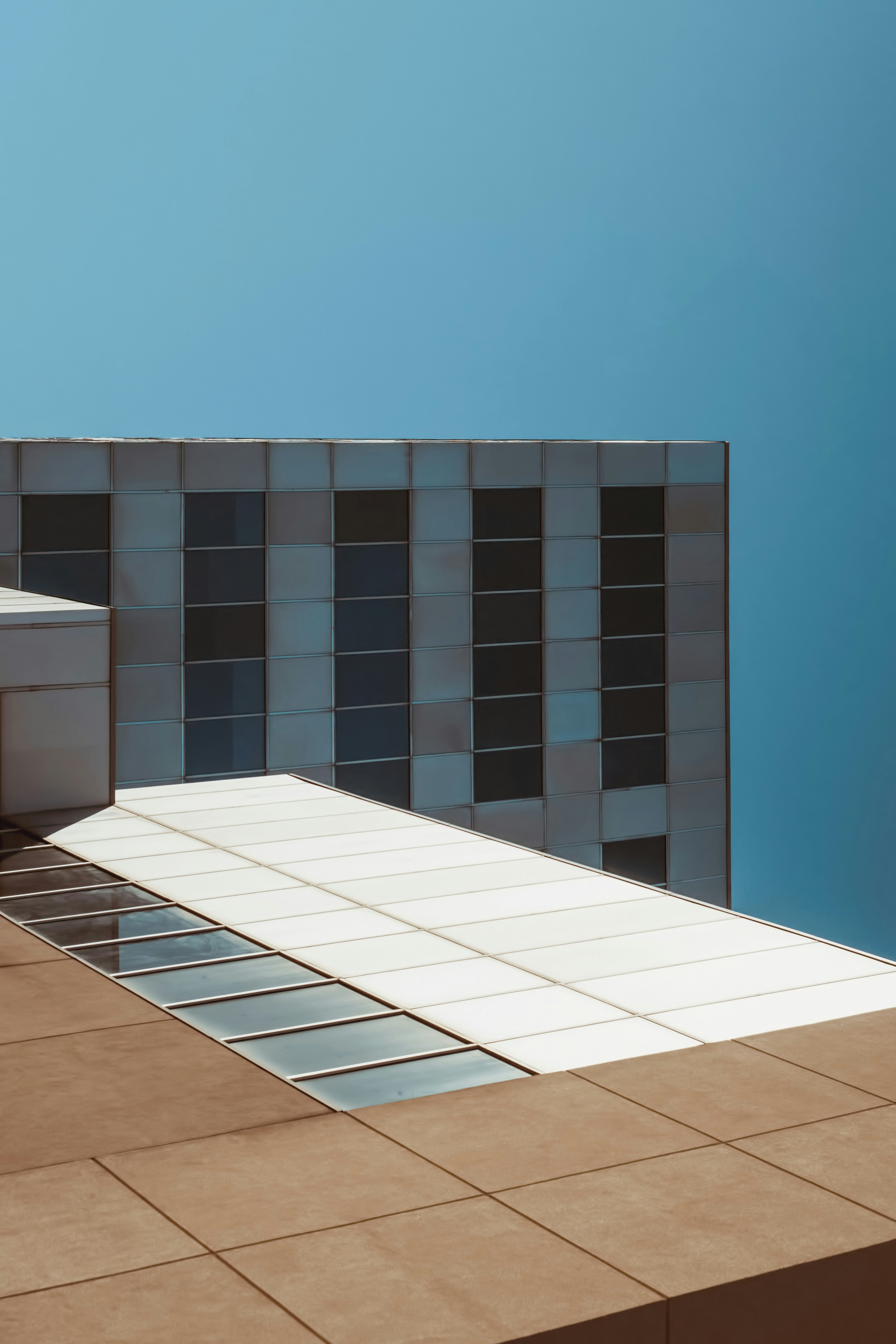 Gray glass building under blue sky photo – Free Building Image on Unsplash