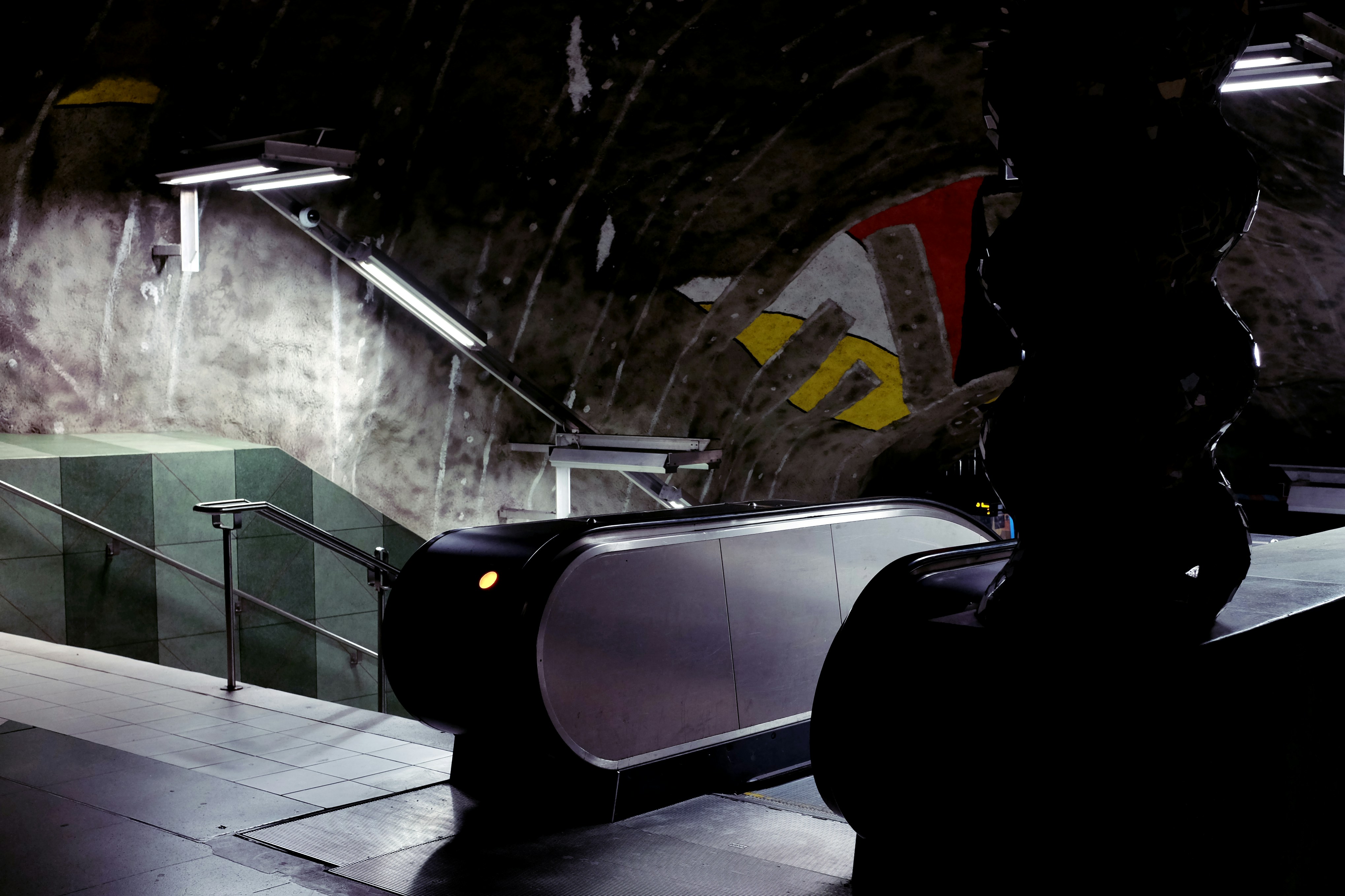 Cavernous Crossing: A Quiet Escalator in a Dim Station
