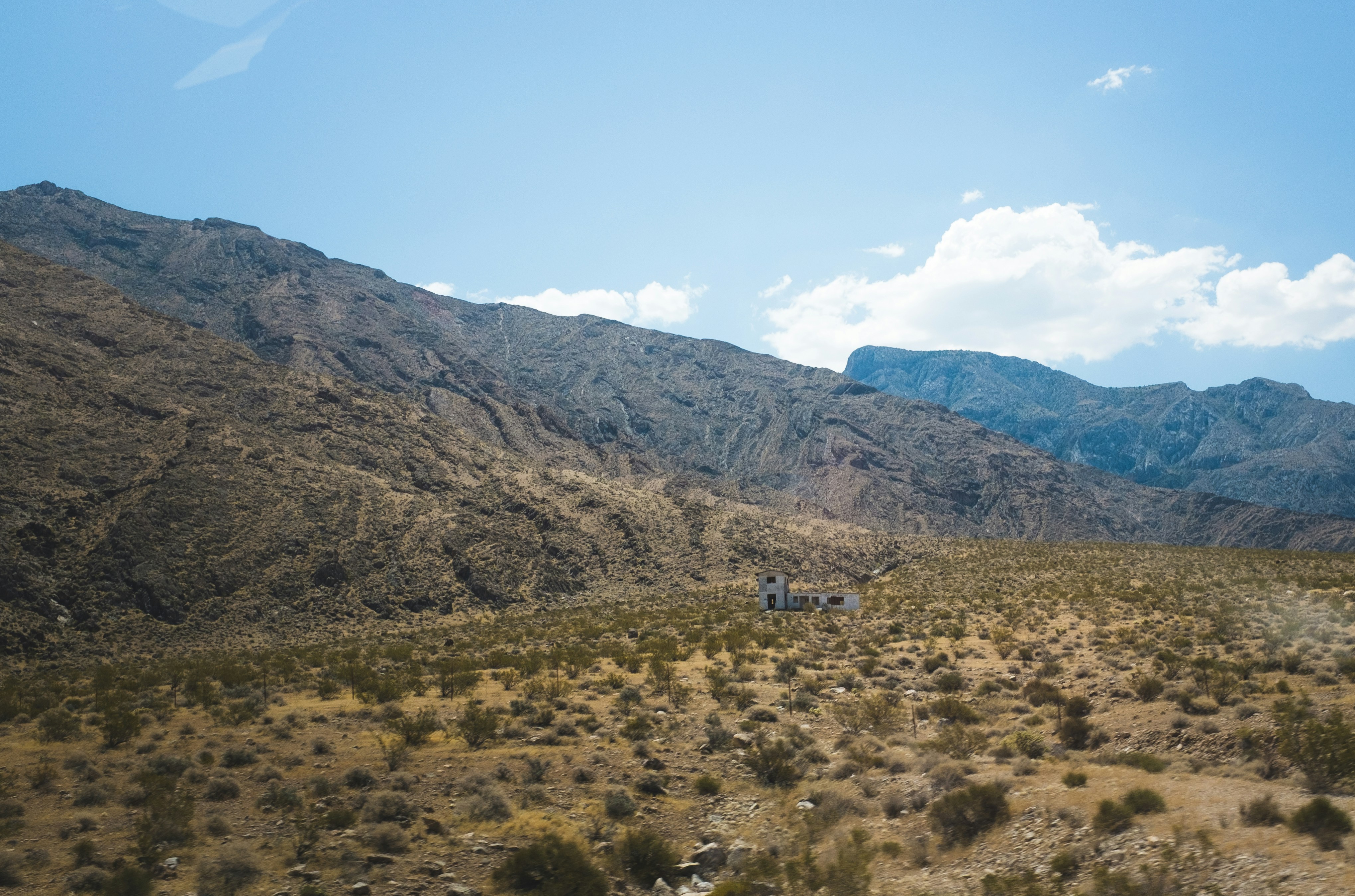 Lone Cabin at the Desert's Edge Beneath a Broad Mountain Sky