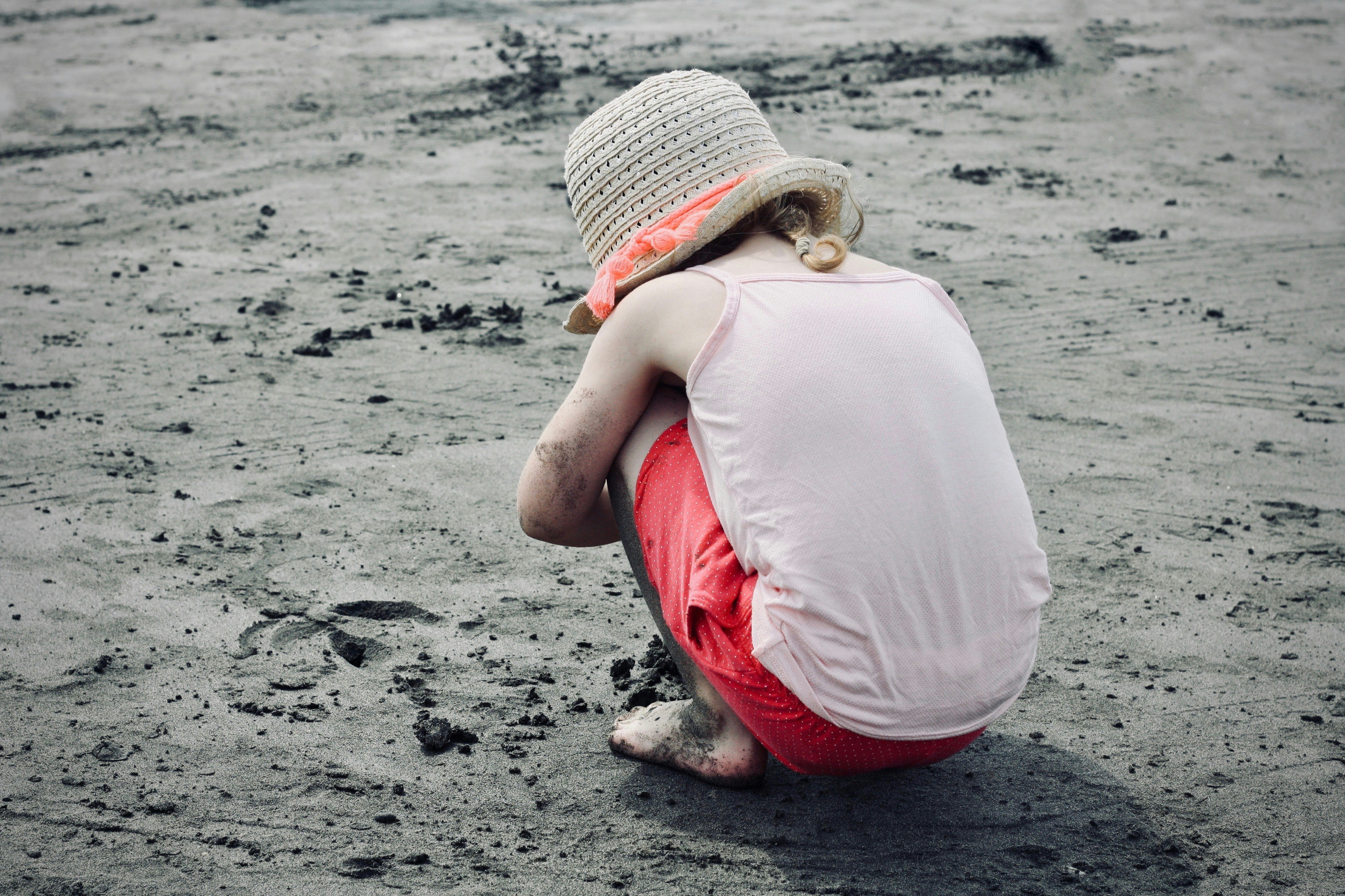 girl playing on black sand