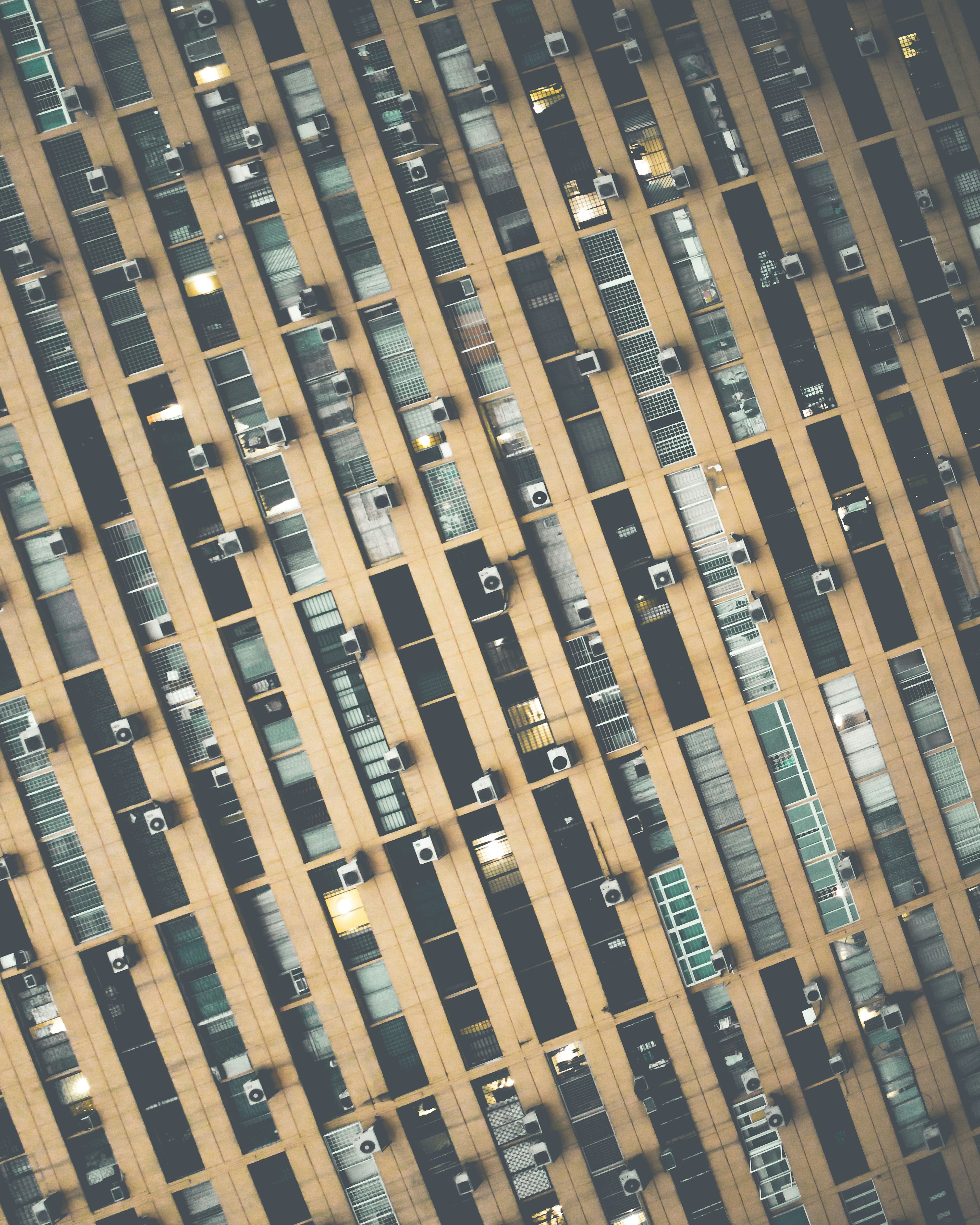 Rhythmic Facade: Tilted Mosaic of Windows and Air Conditioners