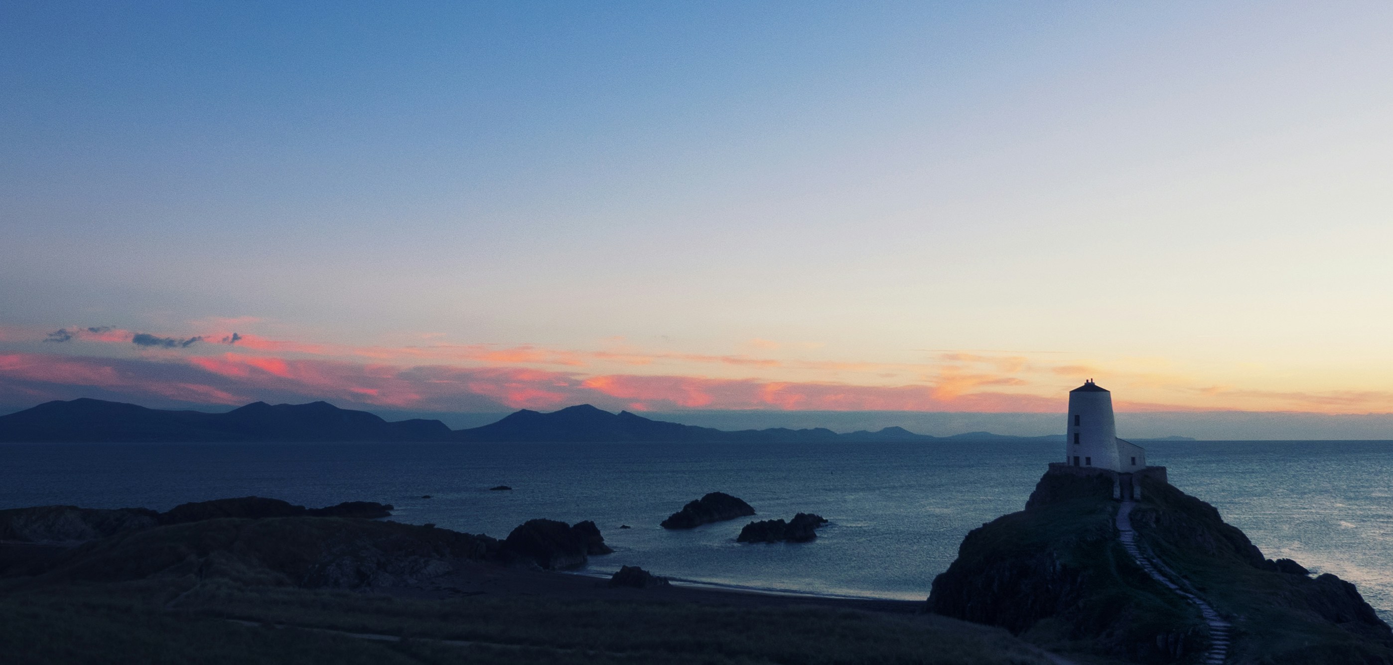 Peace | white lighthouse on hilltop near the sea