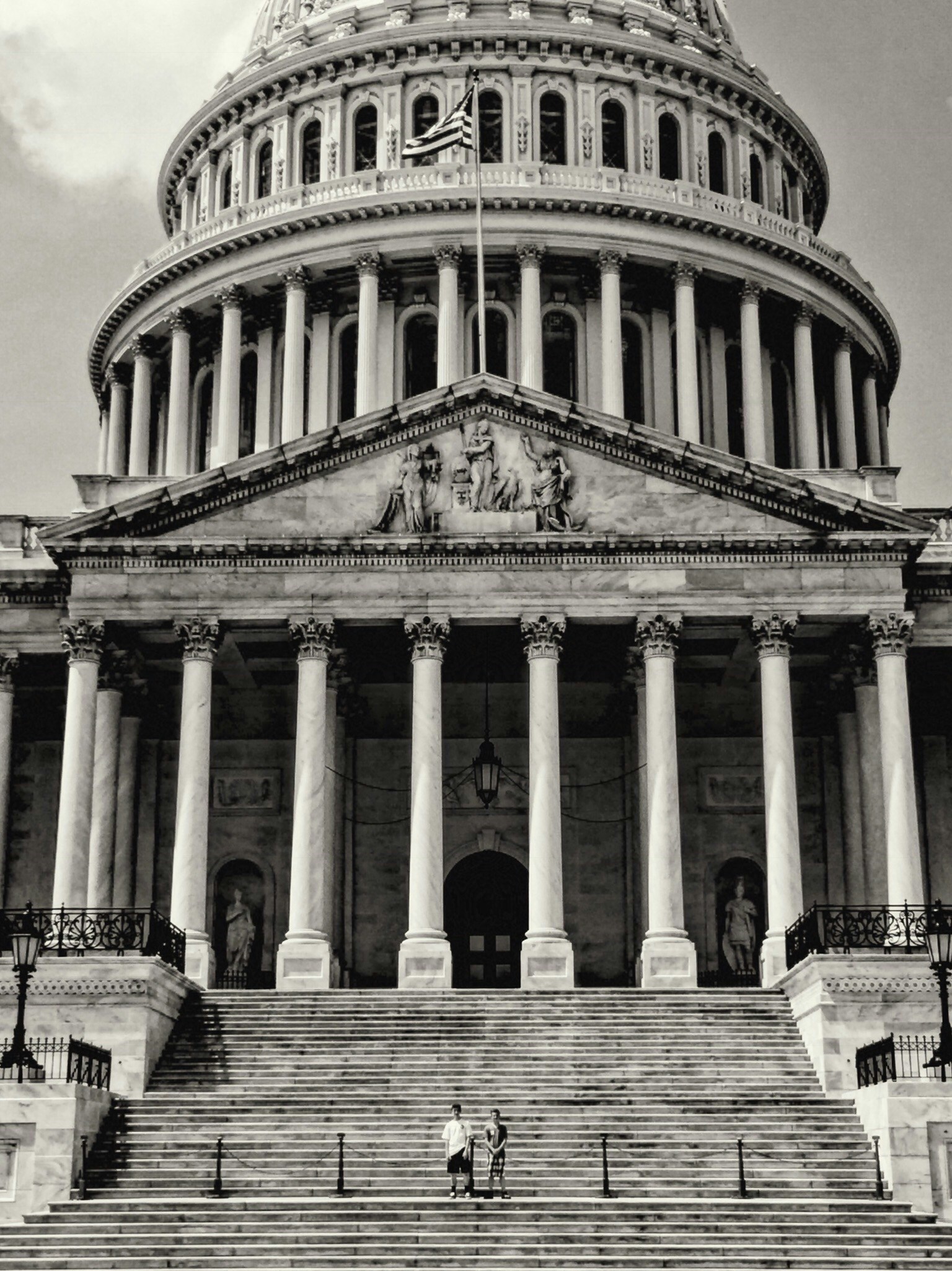 Steps of Grandeur: A Monumental Facade Framed by Two Figures