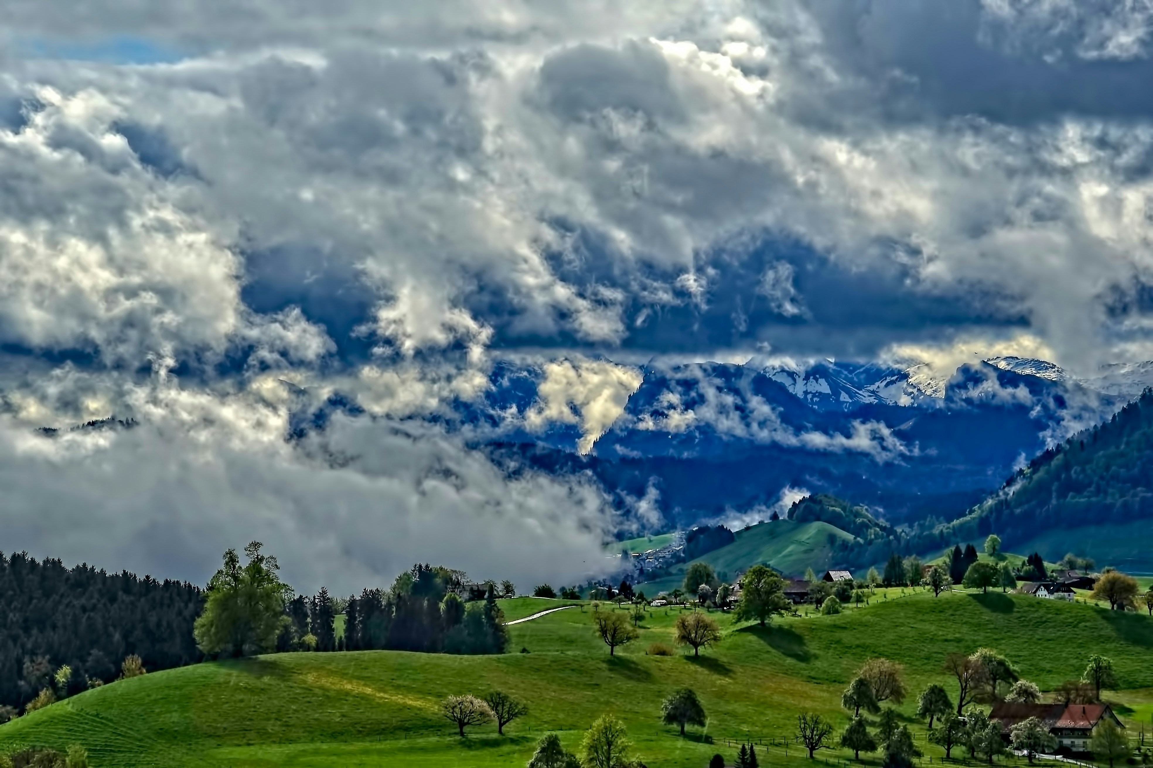 Verdant Alpine Crest Beneath a Roiling Sky