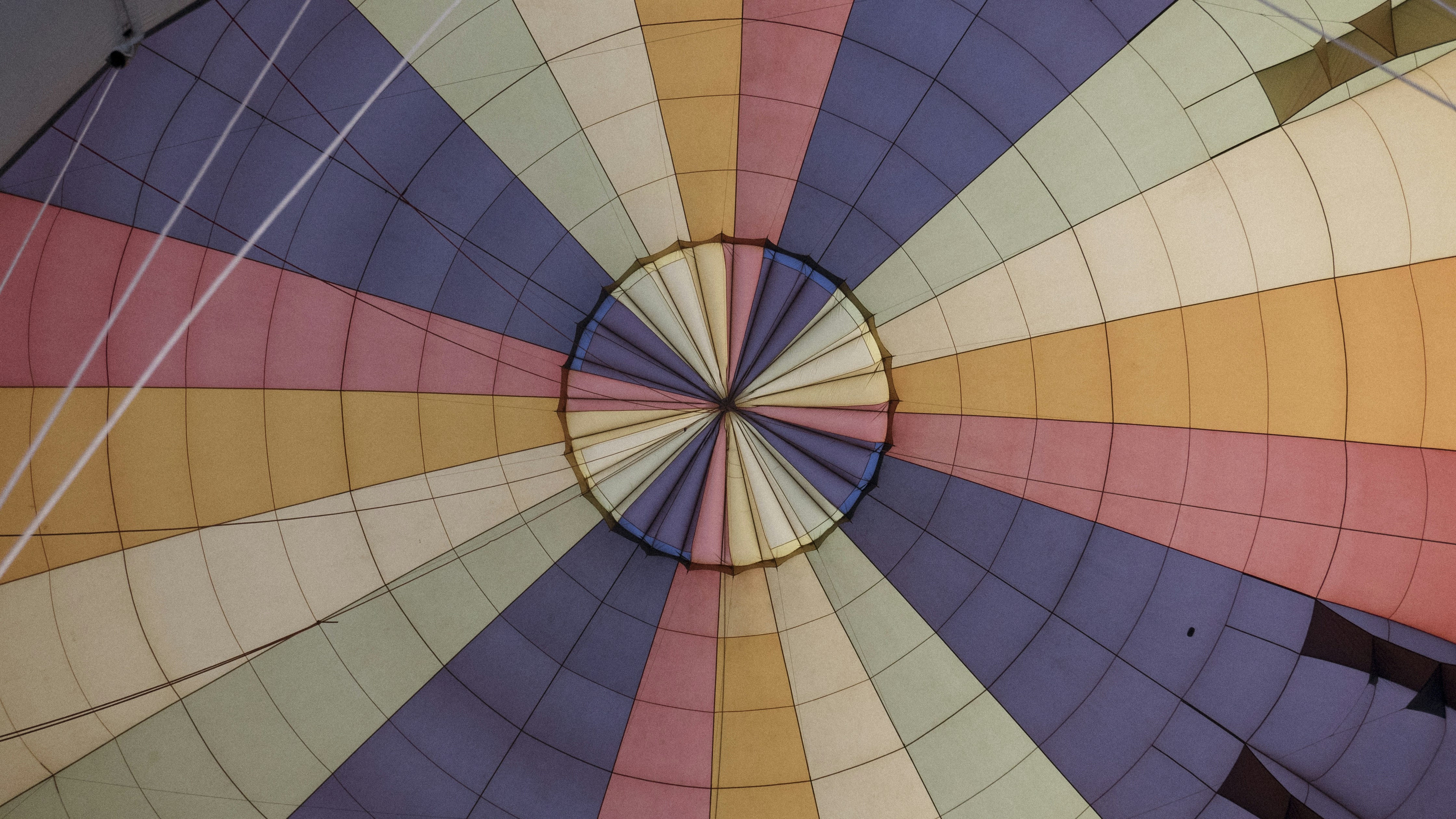 Colorful hot air balloon envelope arranged in a radial pattern with a bright central hub.