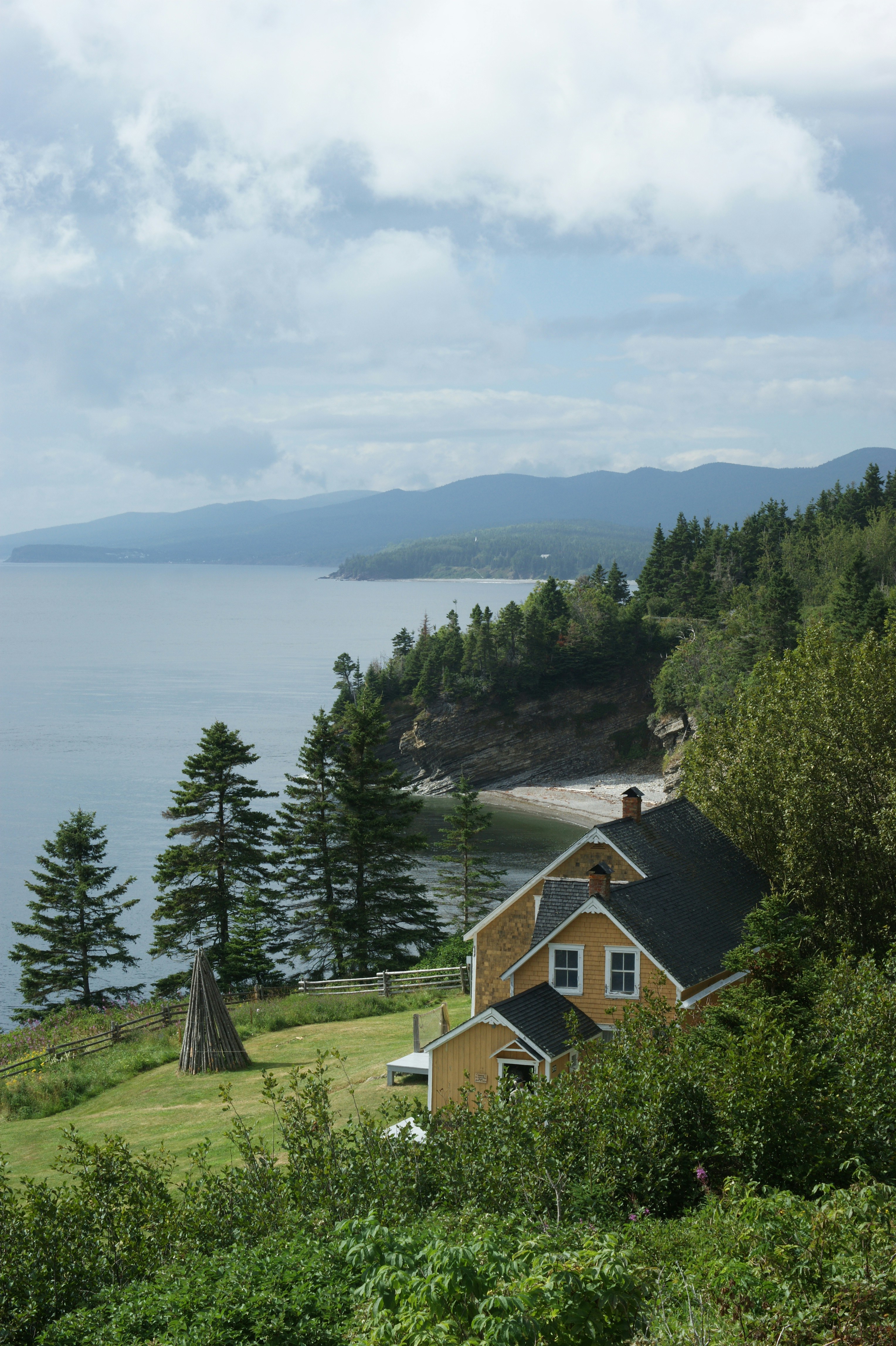 At the edge of Gaspesie | brown and black house surrounded by green trees during daytime