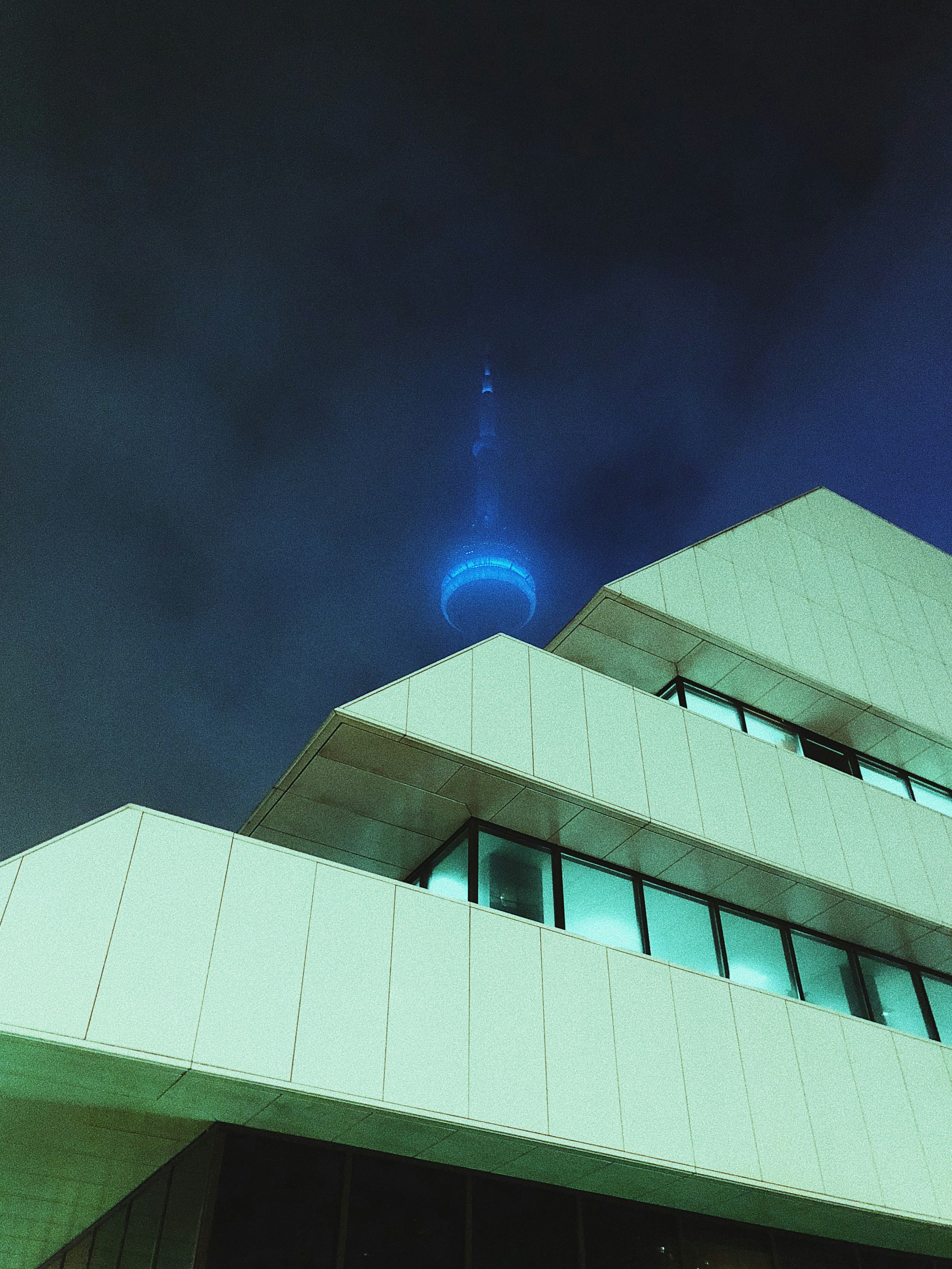 Blue Spire Above Tiered White Facades