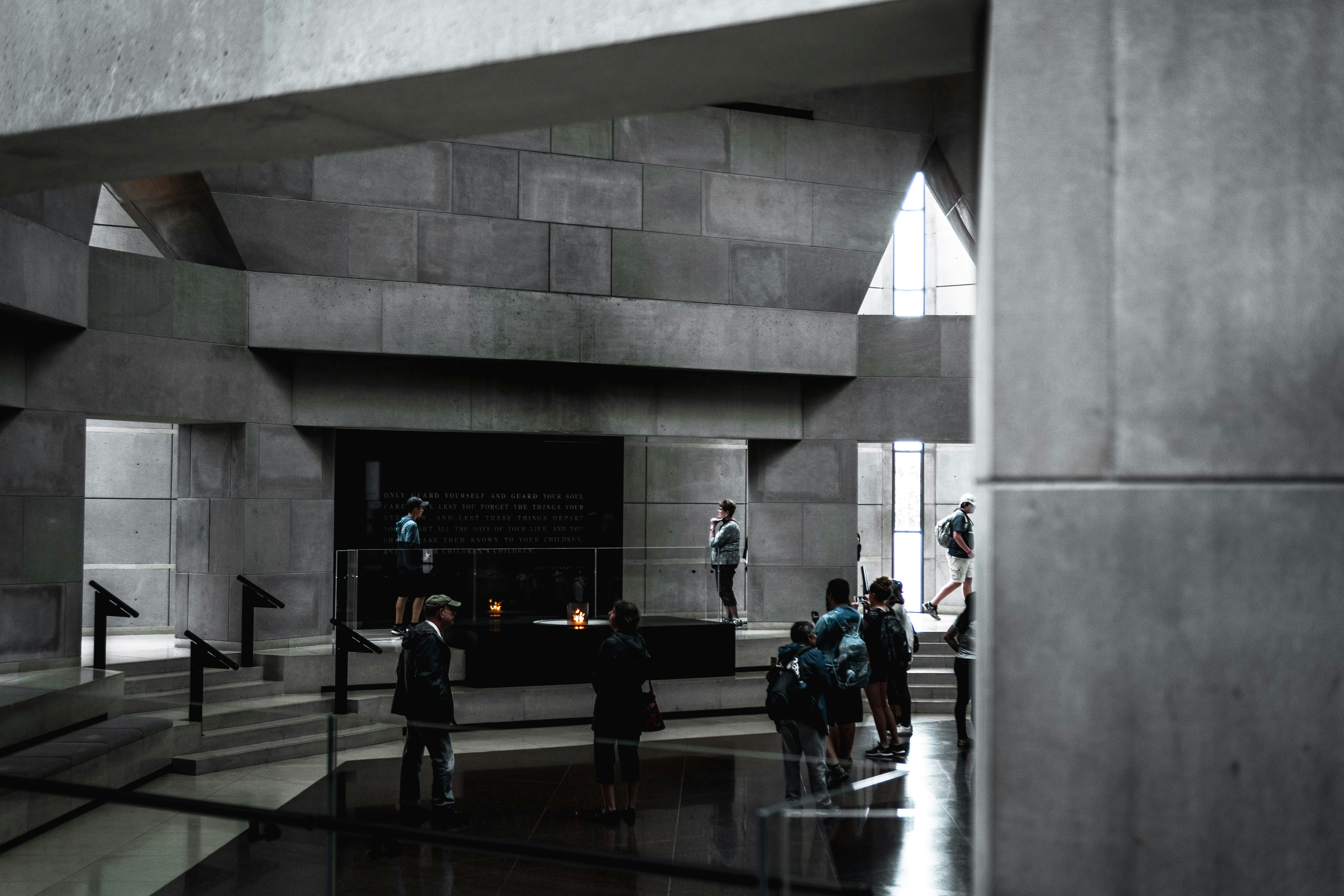 Stage Under Brutalist Arches: A Presenter in a Concrete Atrium