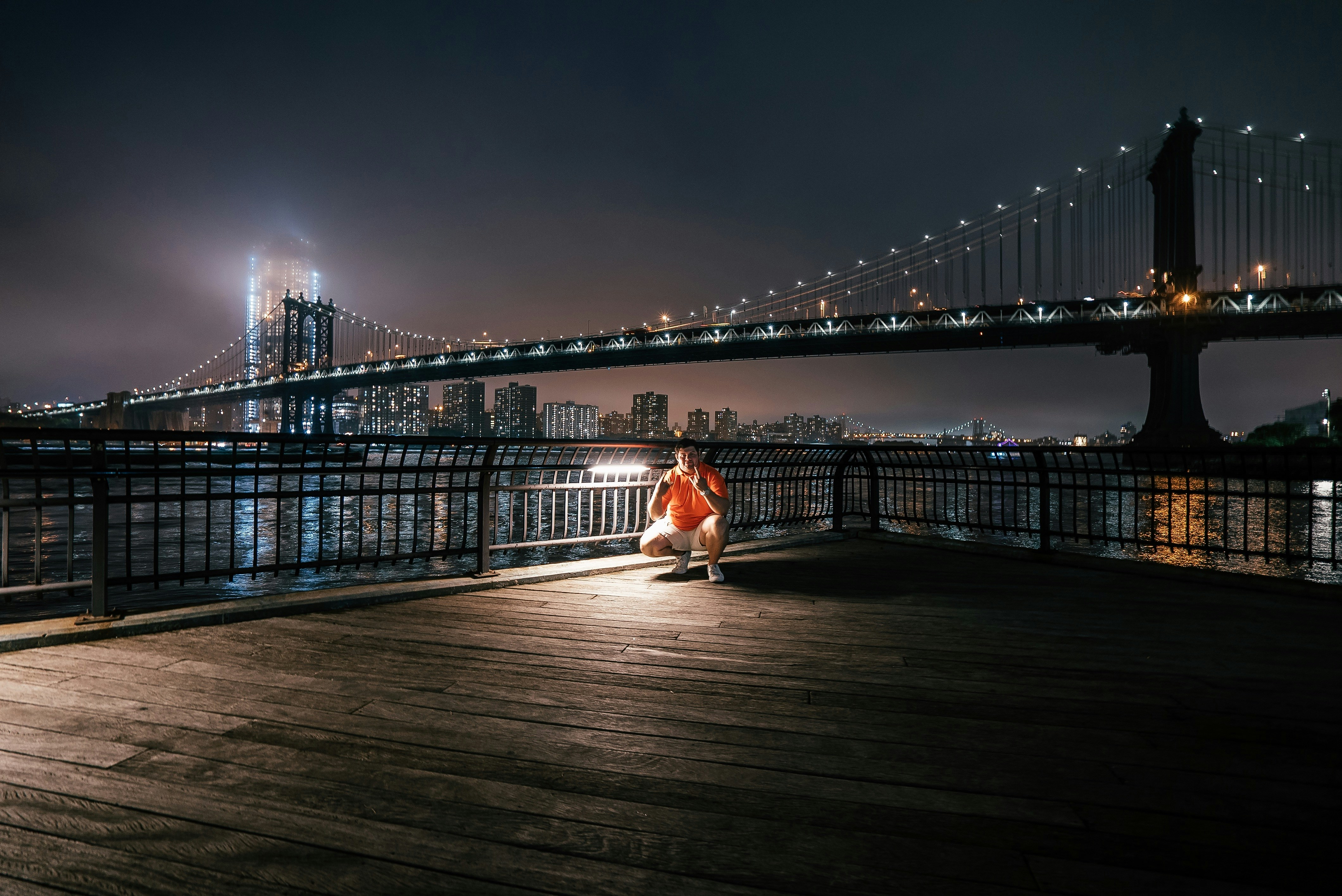 Quiet Portrait on the Waterfront Beneath Brooklyn Bridge Night Lights