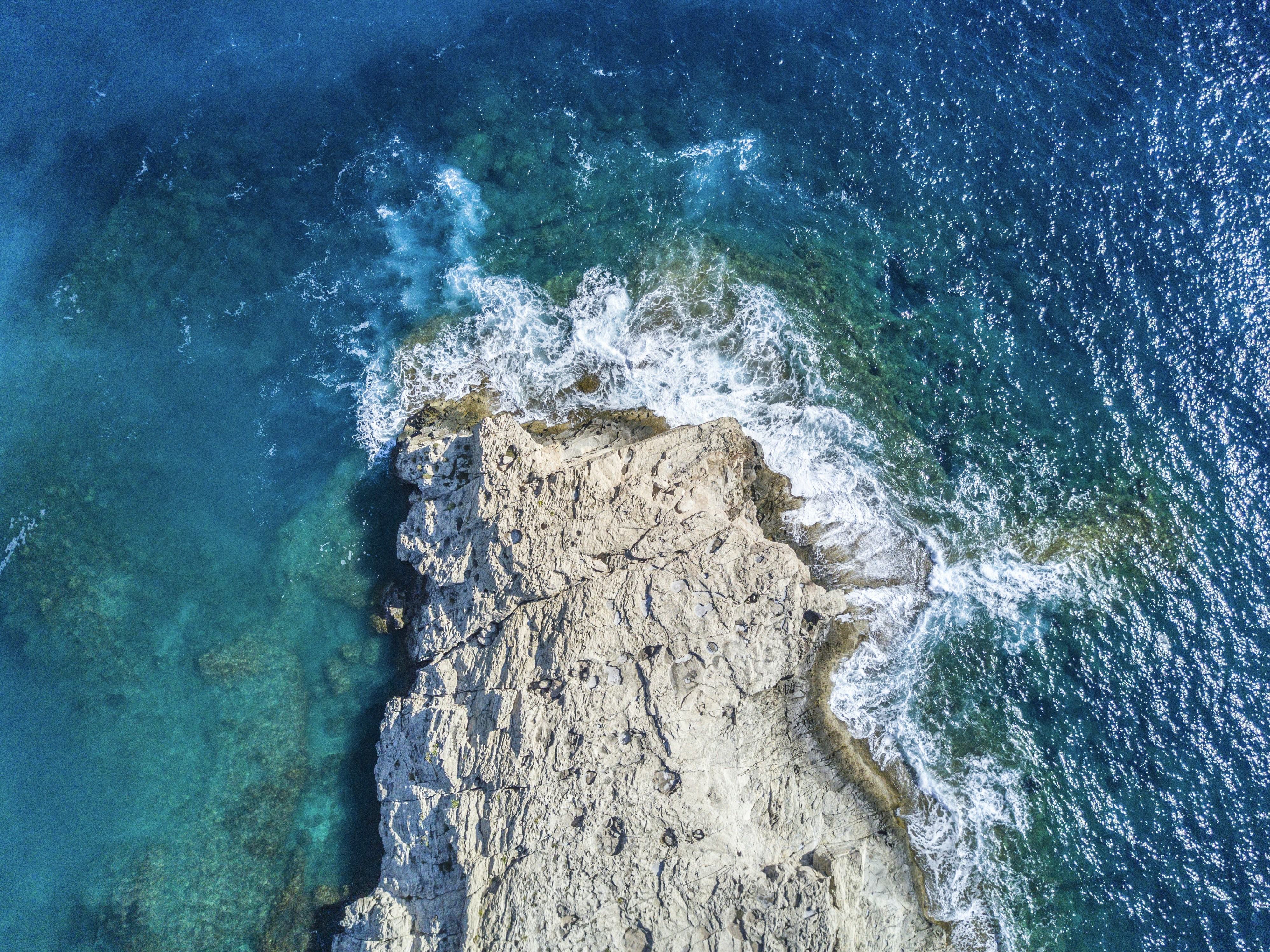 Aerial view of stone beside body of water photo – Free Sea Image on ...