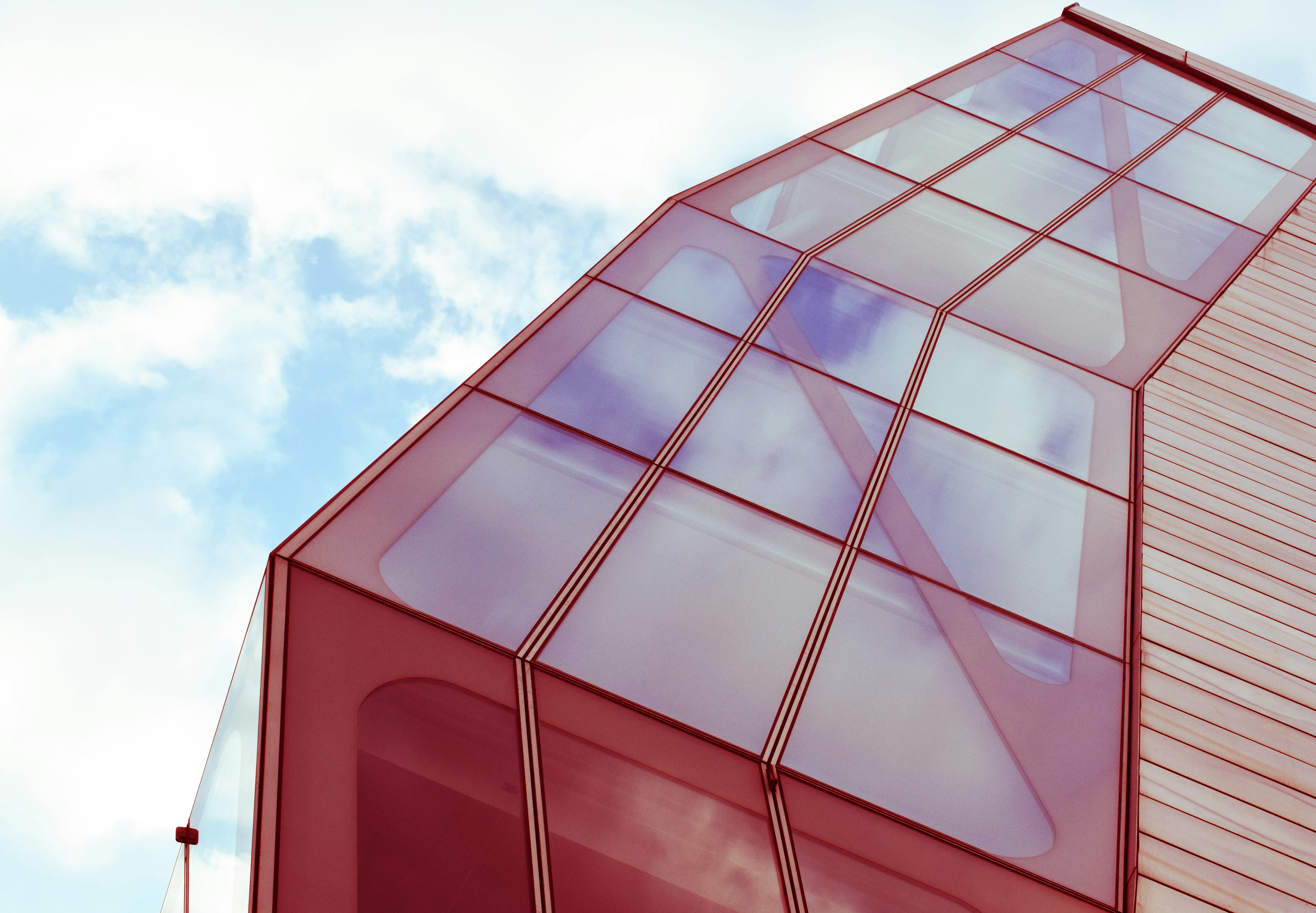 Crimson Prism: A Geometric Glass Facade Reaching for the Sky