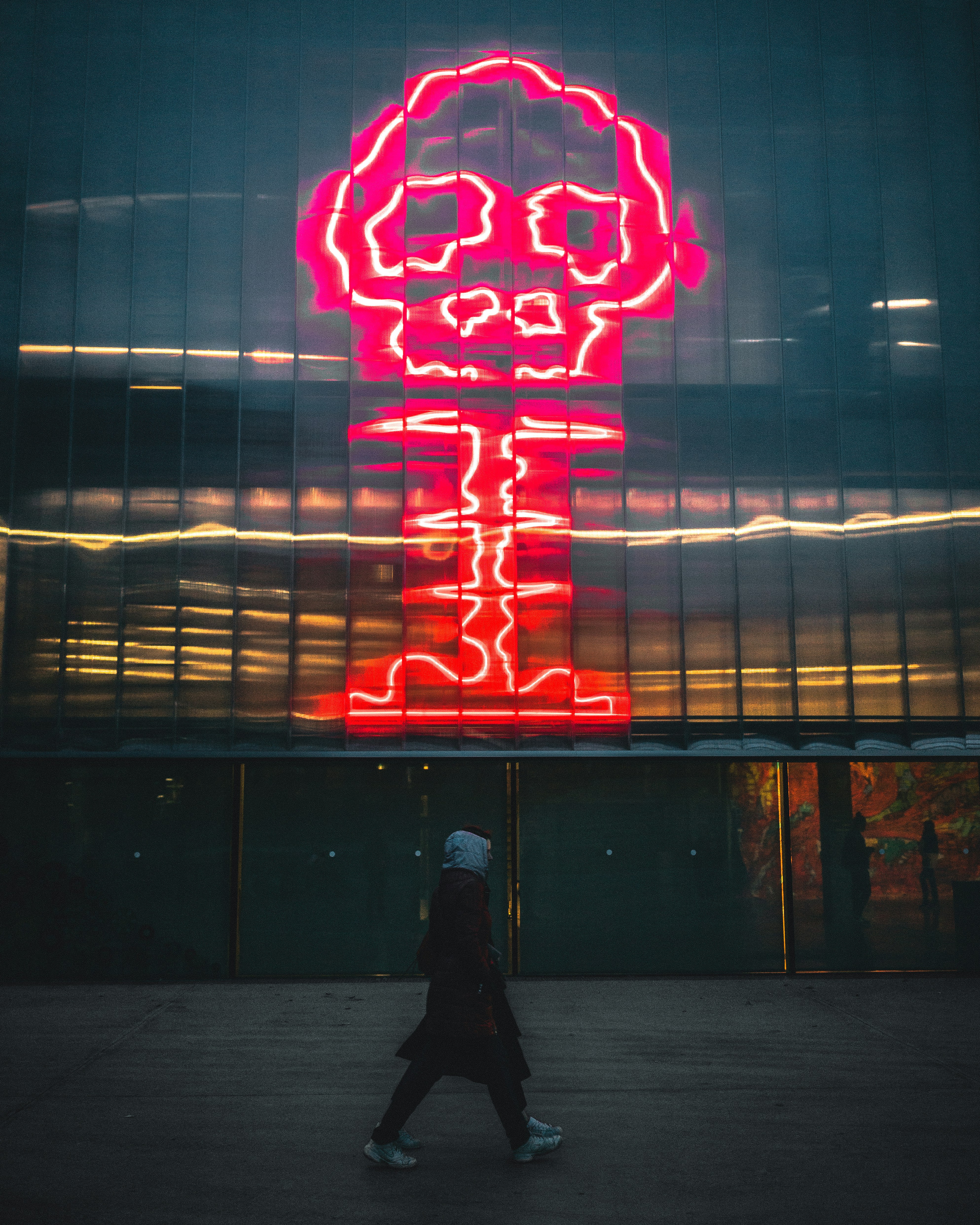 Crimson Neon Skull Over Glass: Night Walk Beneath a Glowing Sign