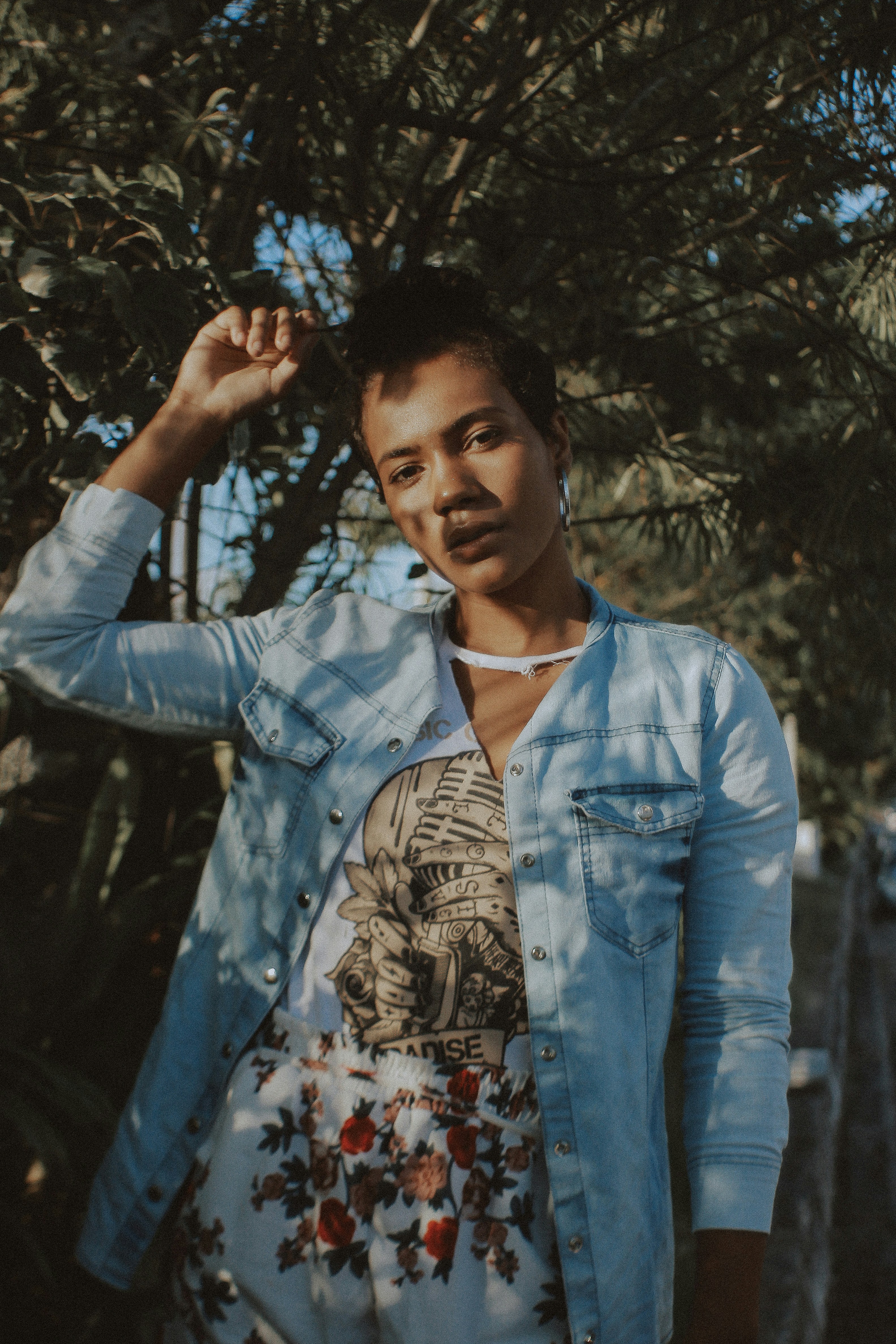 Denim in Dappled Light: Portrait Beneath a Leafy Canopy