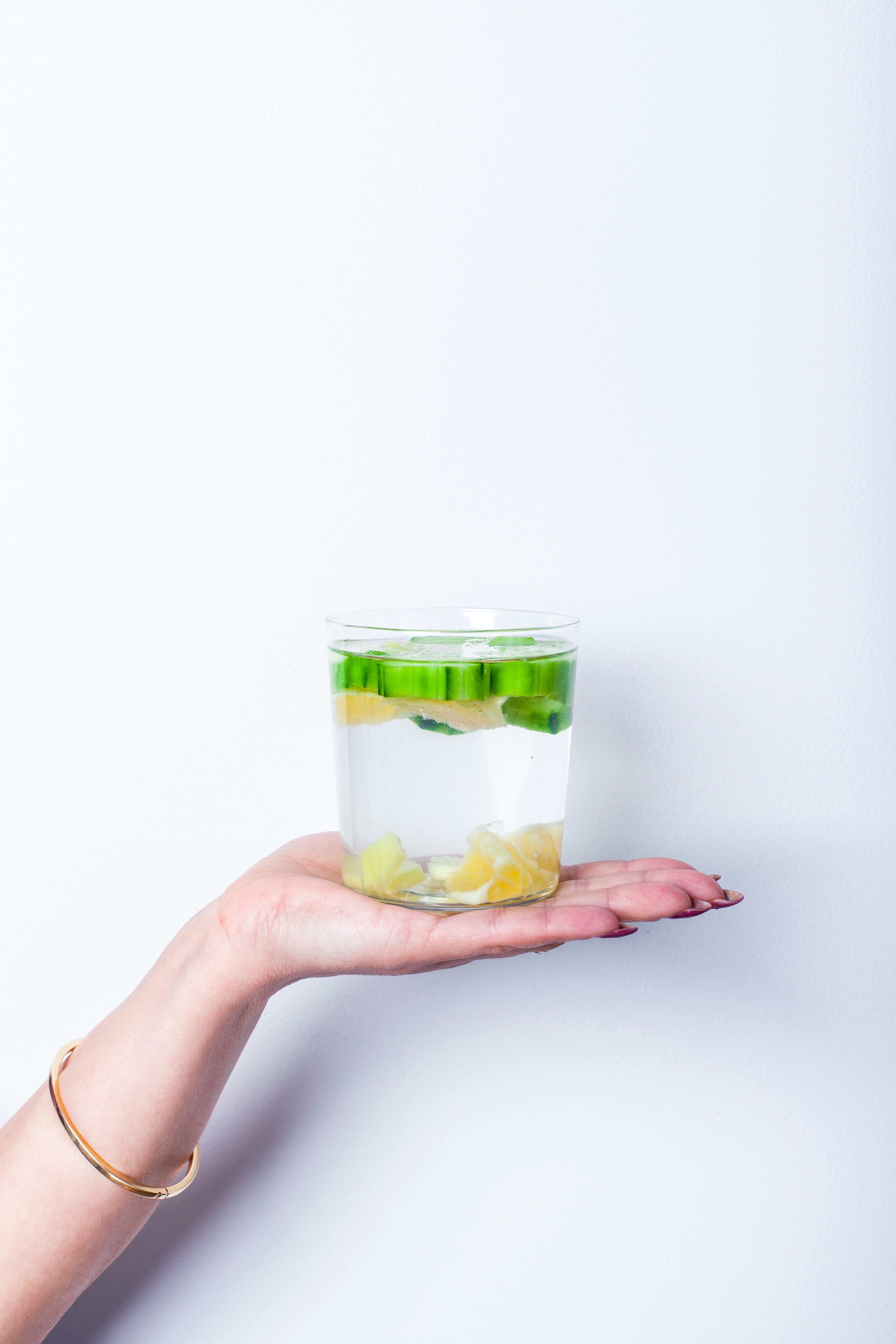 Palm-Held Citrus Infusion: Lemon and Cucumber in Crystal Water