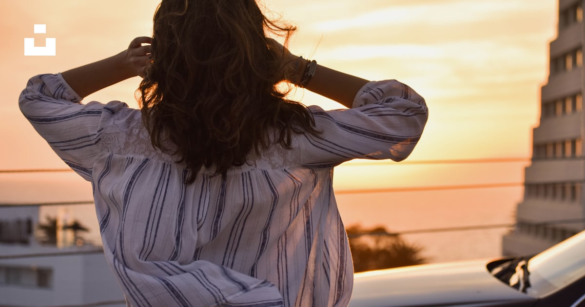 Woman In Blue And White Top Holding Her Hair Photo Free Balcony Image